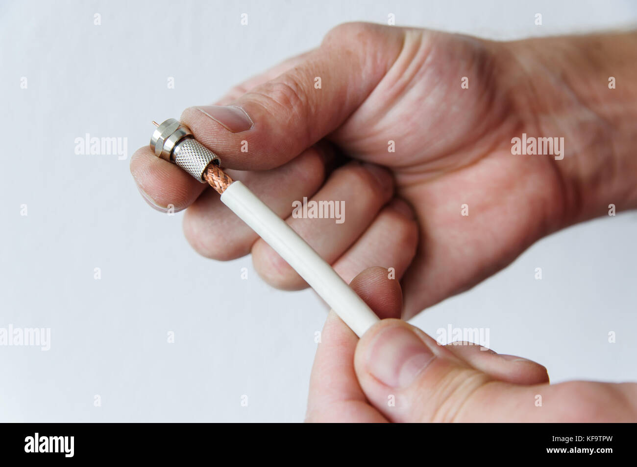 Close-up of a human hand mounted TV connector for coaxial cable Stock ...