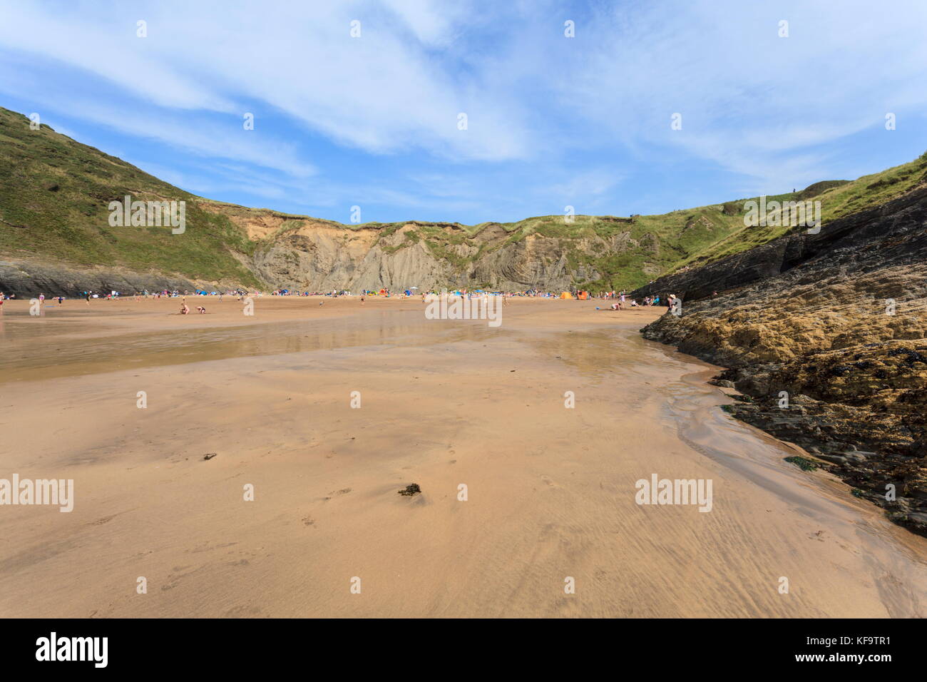A view looking up Mwnt beach from the low tide mark on a summers day ...