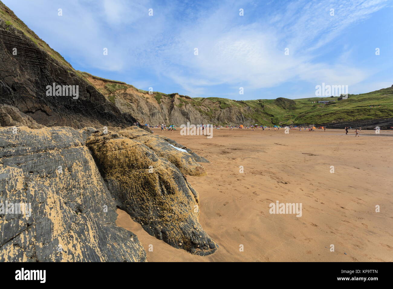 A view looking up Mwnt beach from the low tide mark on a summers day ...