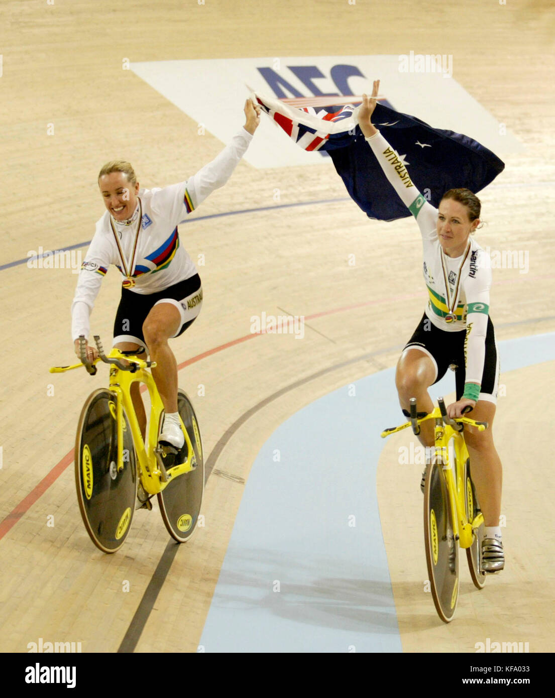 Katie Mactier of Australia, left, waves her country's flag while taking ...