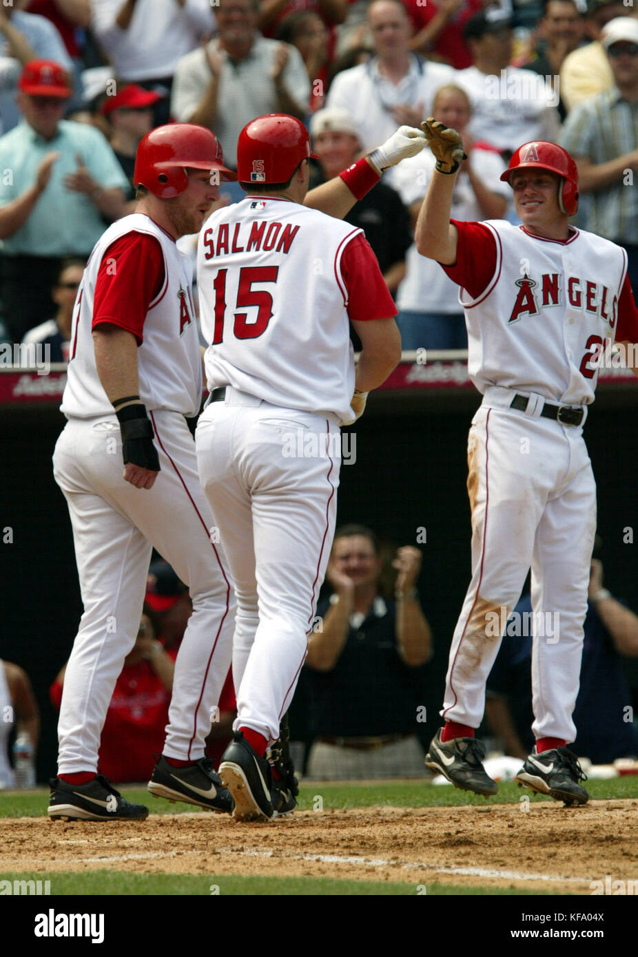 Anaheim Angels batter Tim Salmon, #15, is greeted at home plate by ...