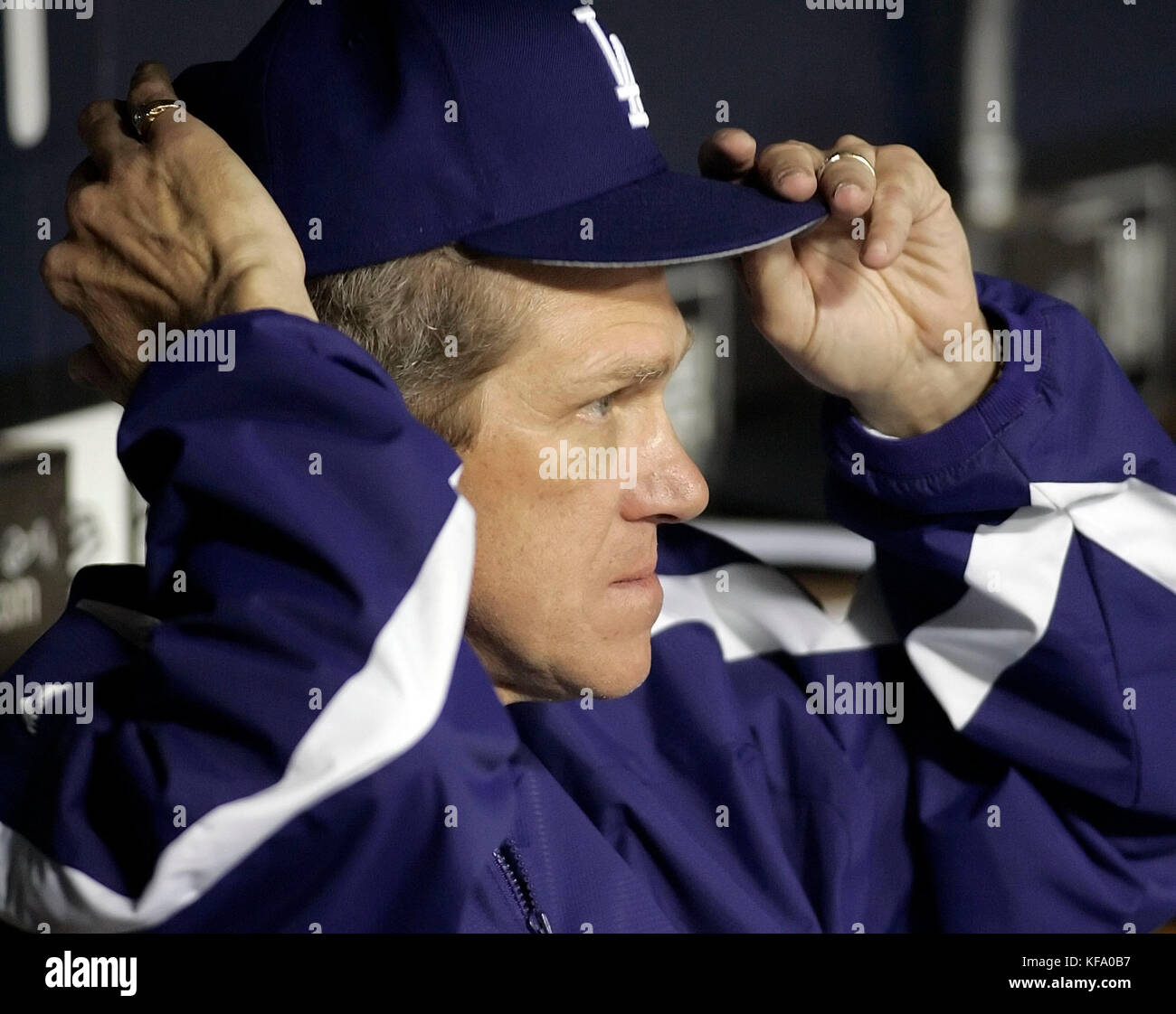 Los Angeles Dodgers manager Jim Tracy watches his team from the dugout ...