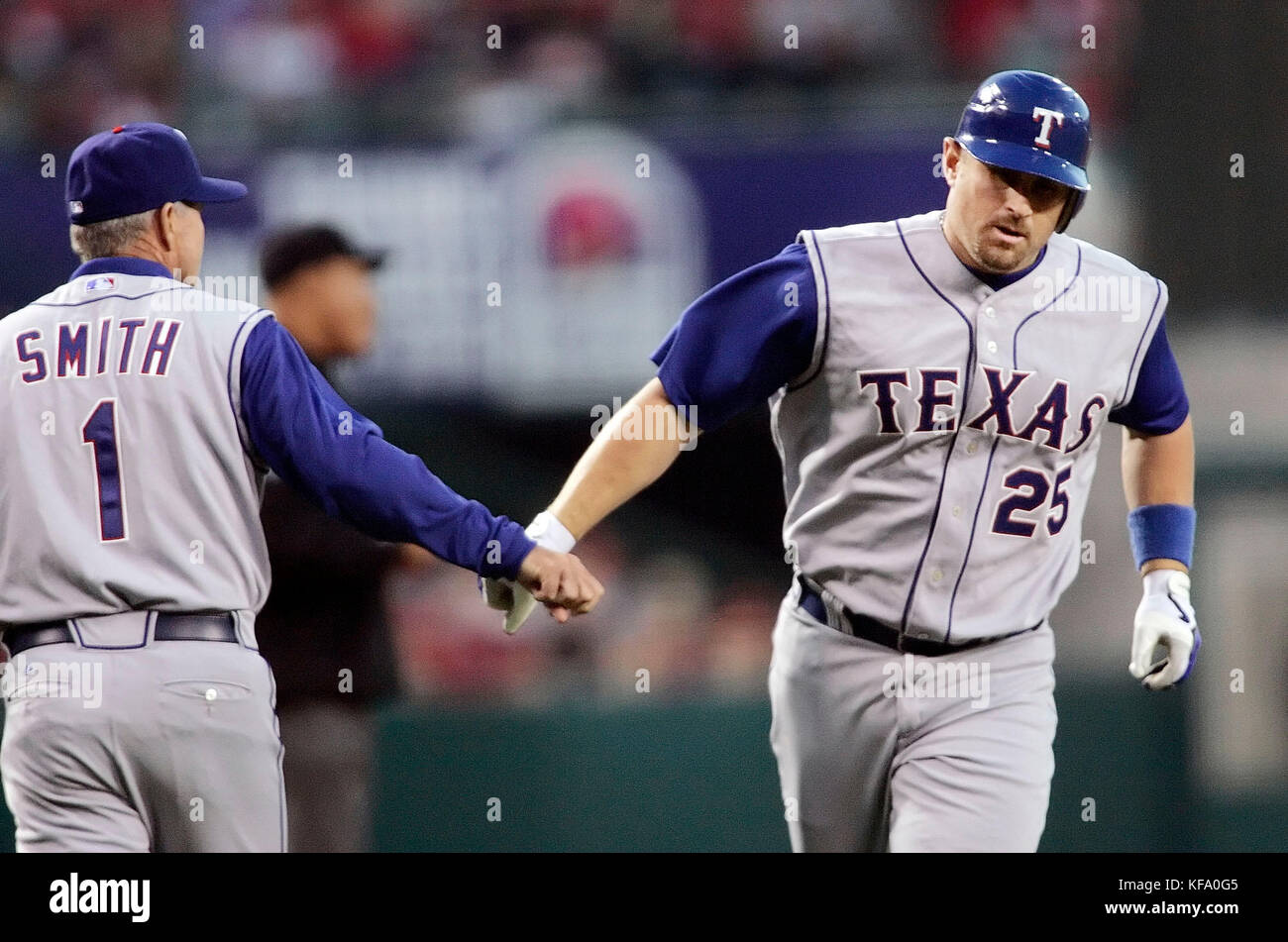 Texas Rangers' Phil Nevin, right, is greeted by Rangers' third base ...