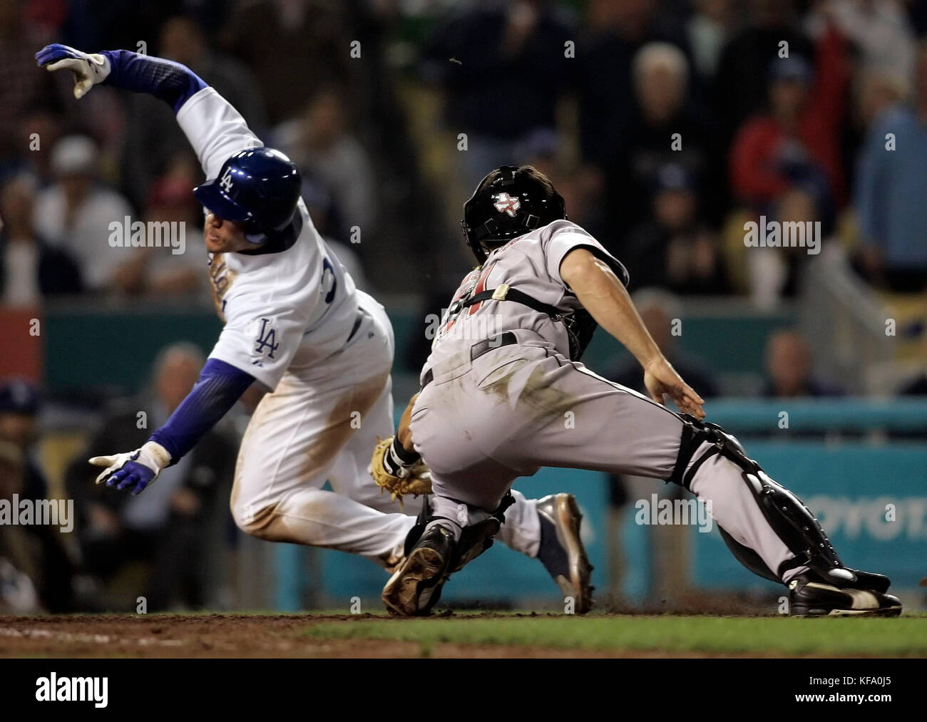 Los Angeles Dodgers' Russell Martin, left, scores by avoiding a tag at ...