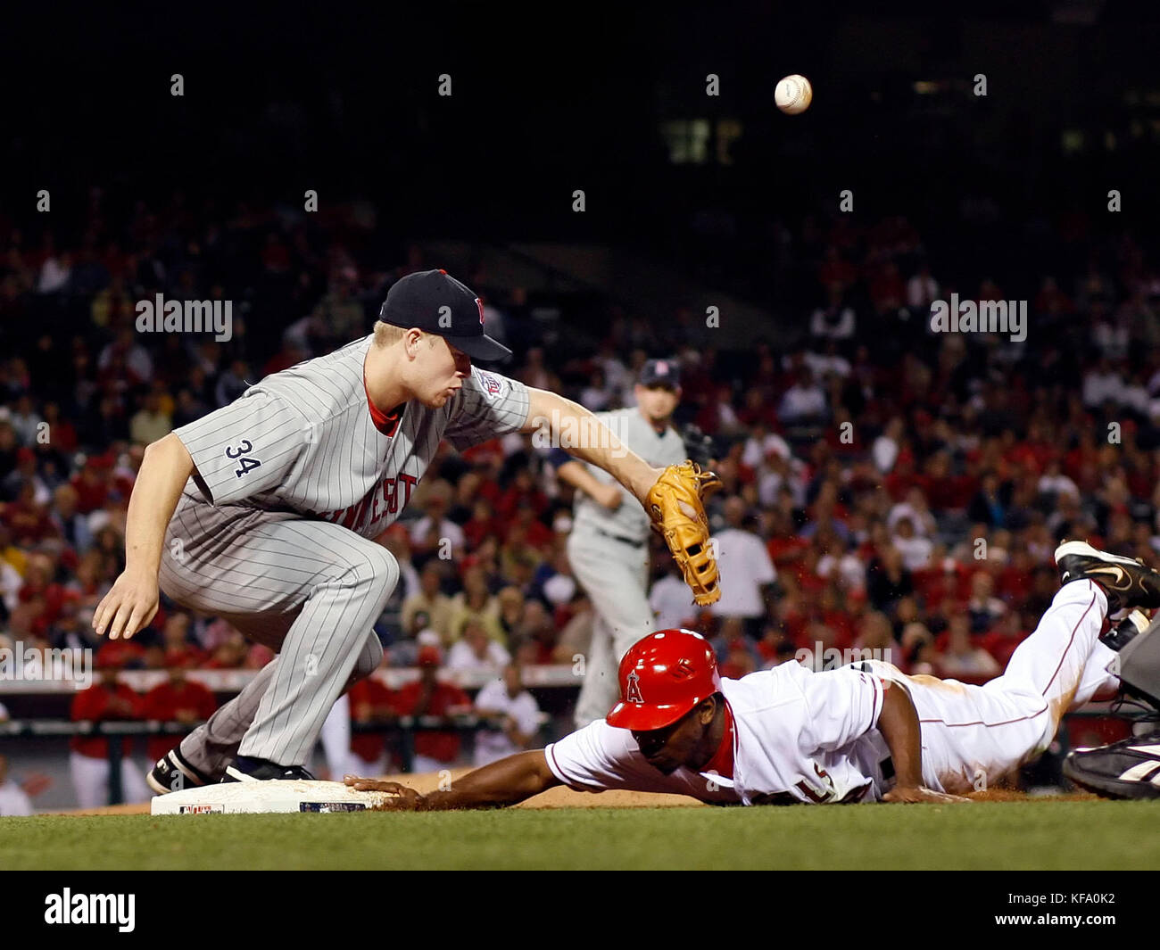 Minnesota Twins first baseman Justin Morneau, left, can't handle an ...
