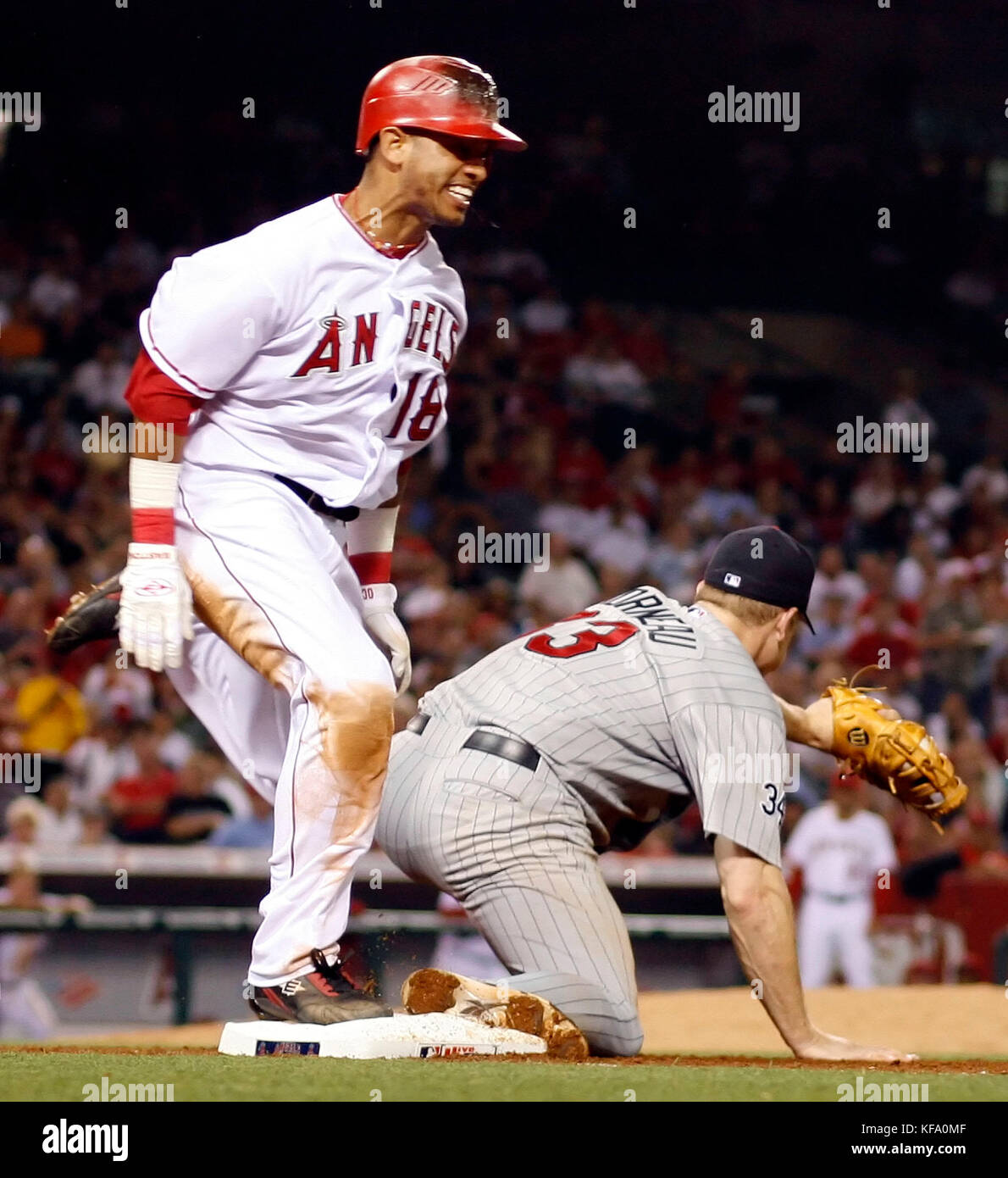 Los Angeles Angels' Orlando Cabrera, left, runs to first base as ...
