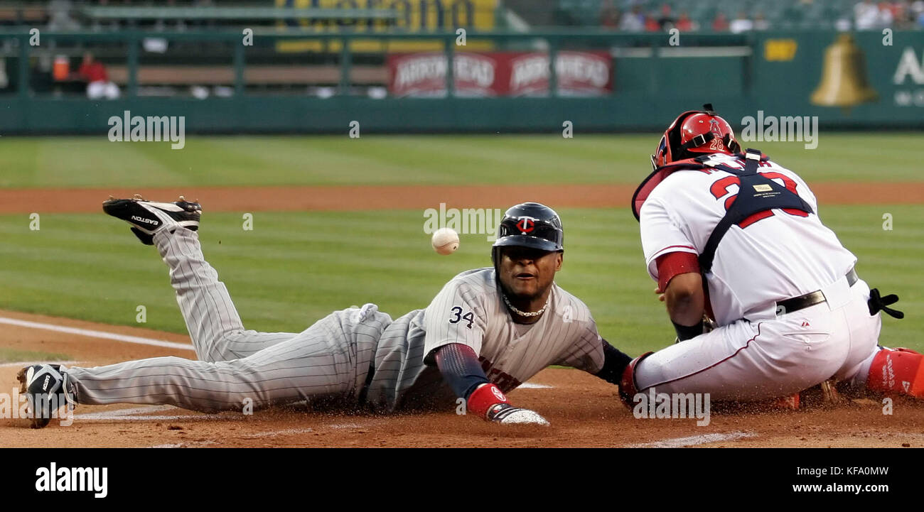 Minnesota Twins' Luis Castillo, left, slides safely into home as the ...