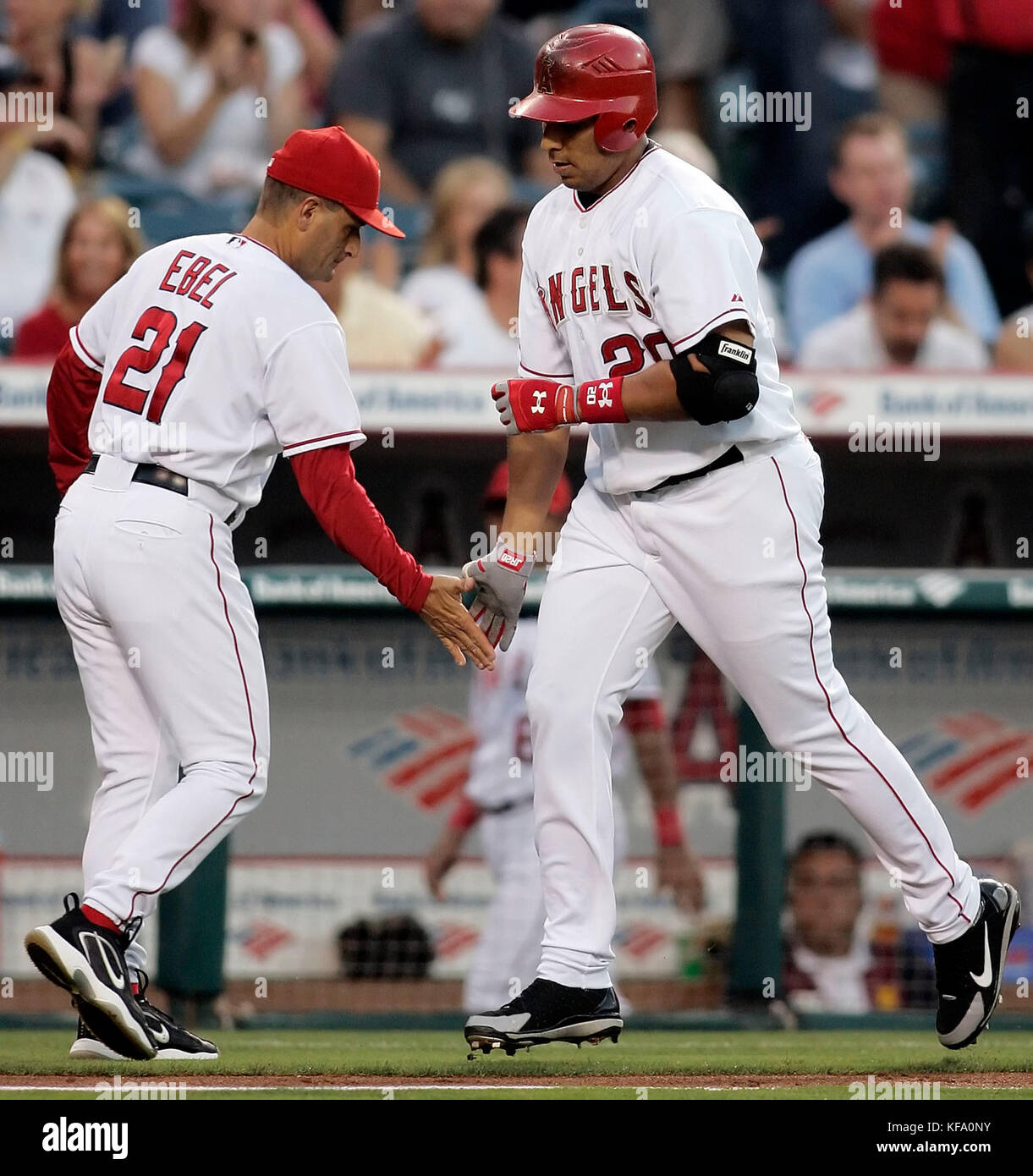 Los Angeles Angels' Juan Rivera, right, is greeted by third base coach ...
