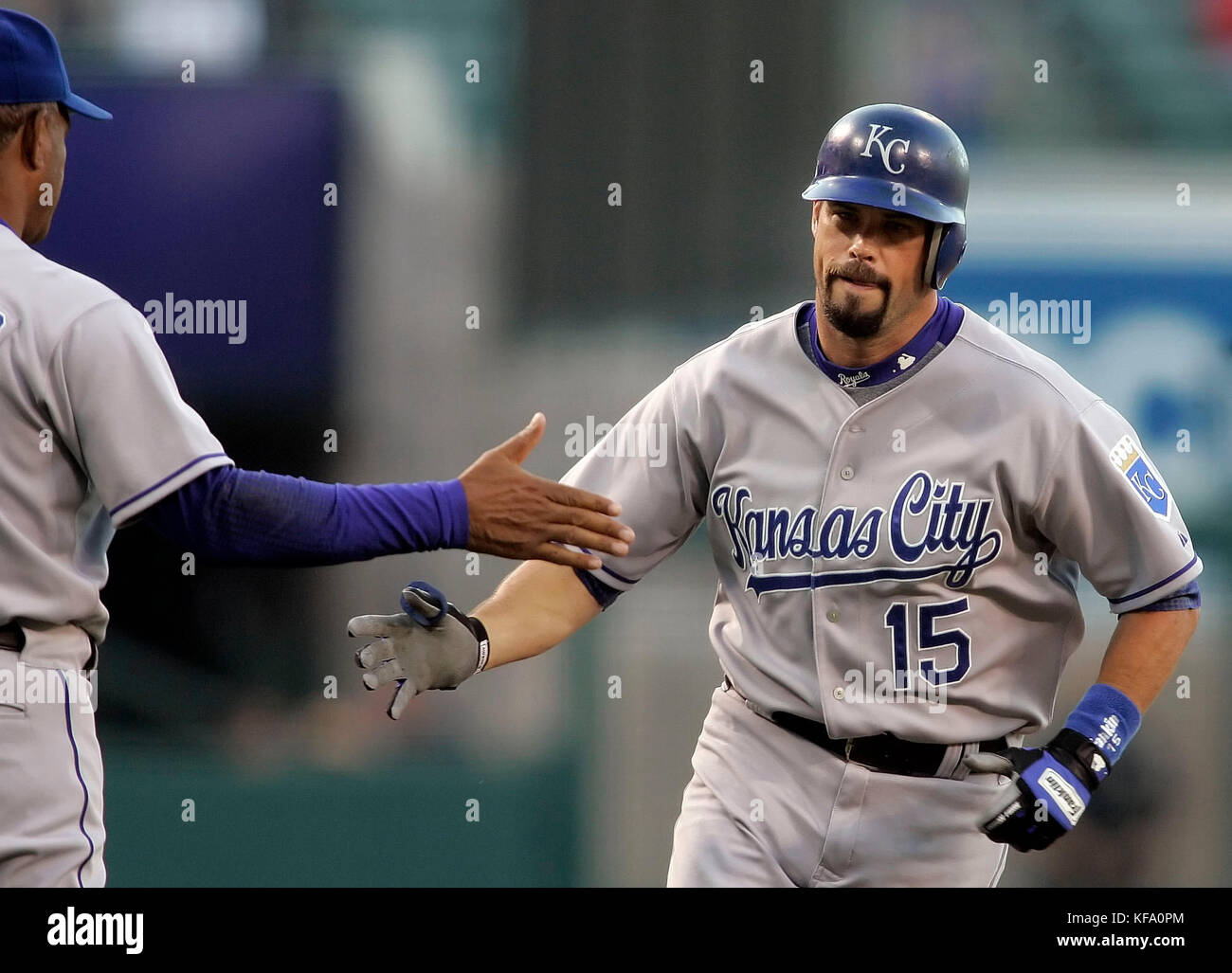 Kansas City Royals' Mark Grudzielanek, right, is greeted by third base ...
