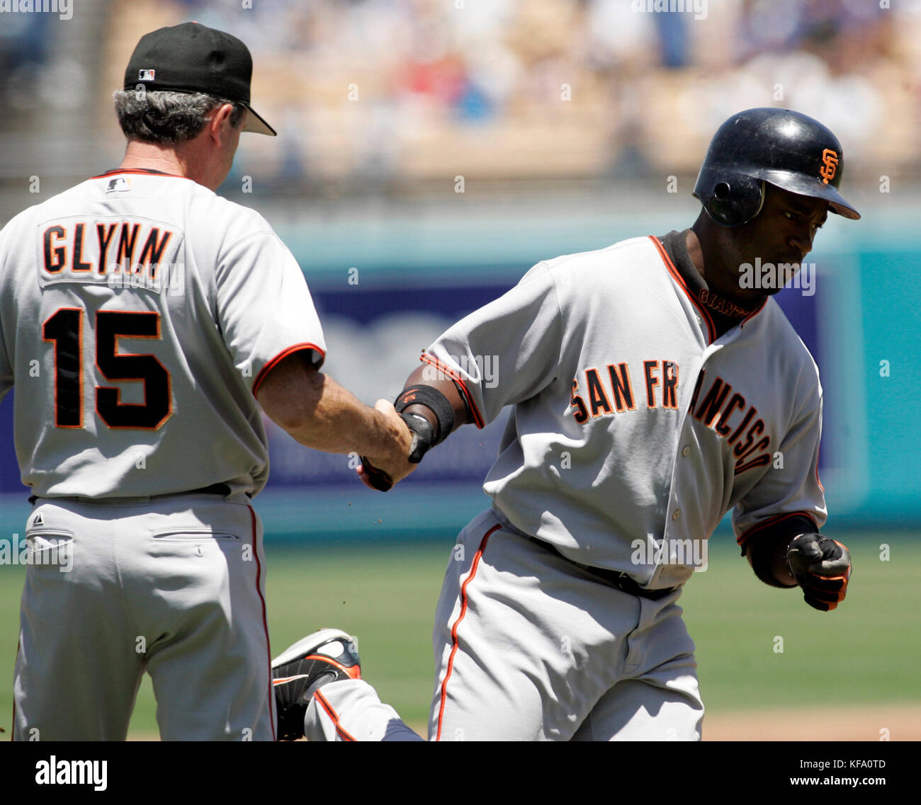 San Francisco Giants' Ray Durham, right, is greeted by third base coach ...