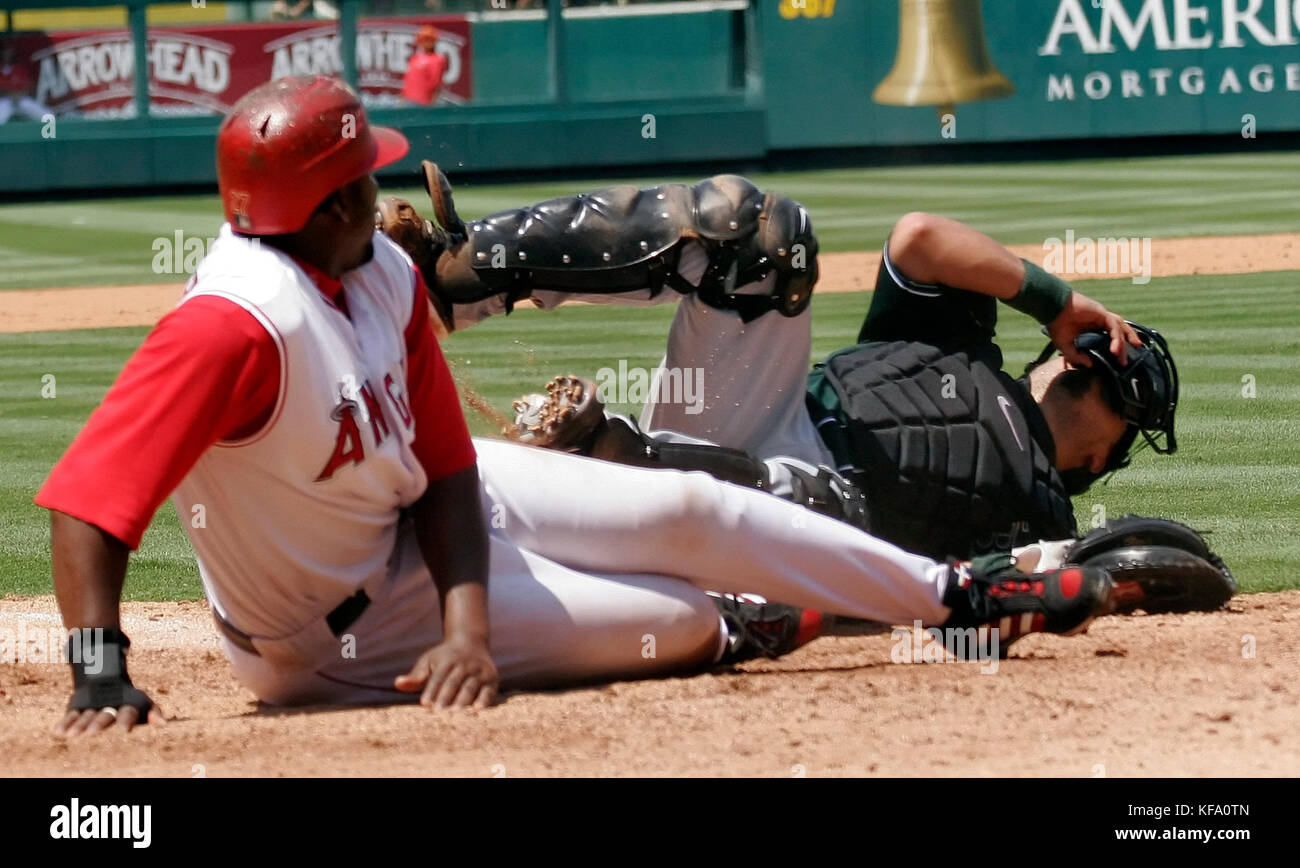 Tampa Bay Devil Rays catcher Dioner Navarro, right, lies on the ground ...