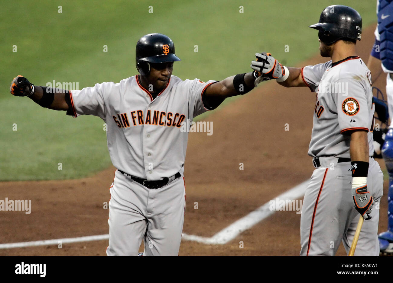 San Francisco Giants' Ray Durham, left, is greeted at home by teammate ...