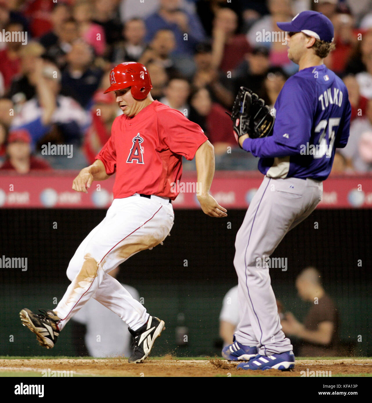 Los Angeles Angels' Robb Quinlan, left, scores from third base on a ...