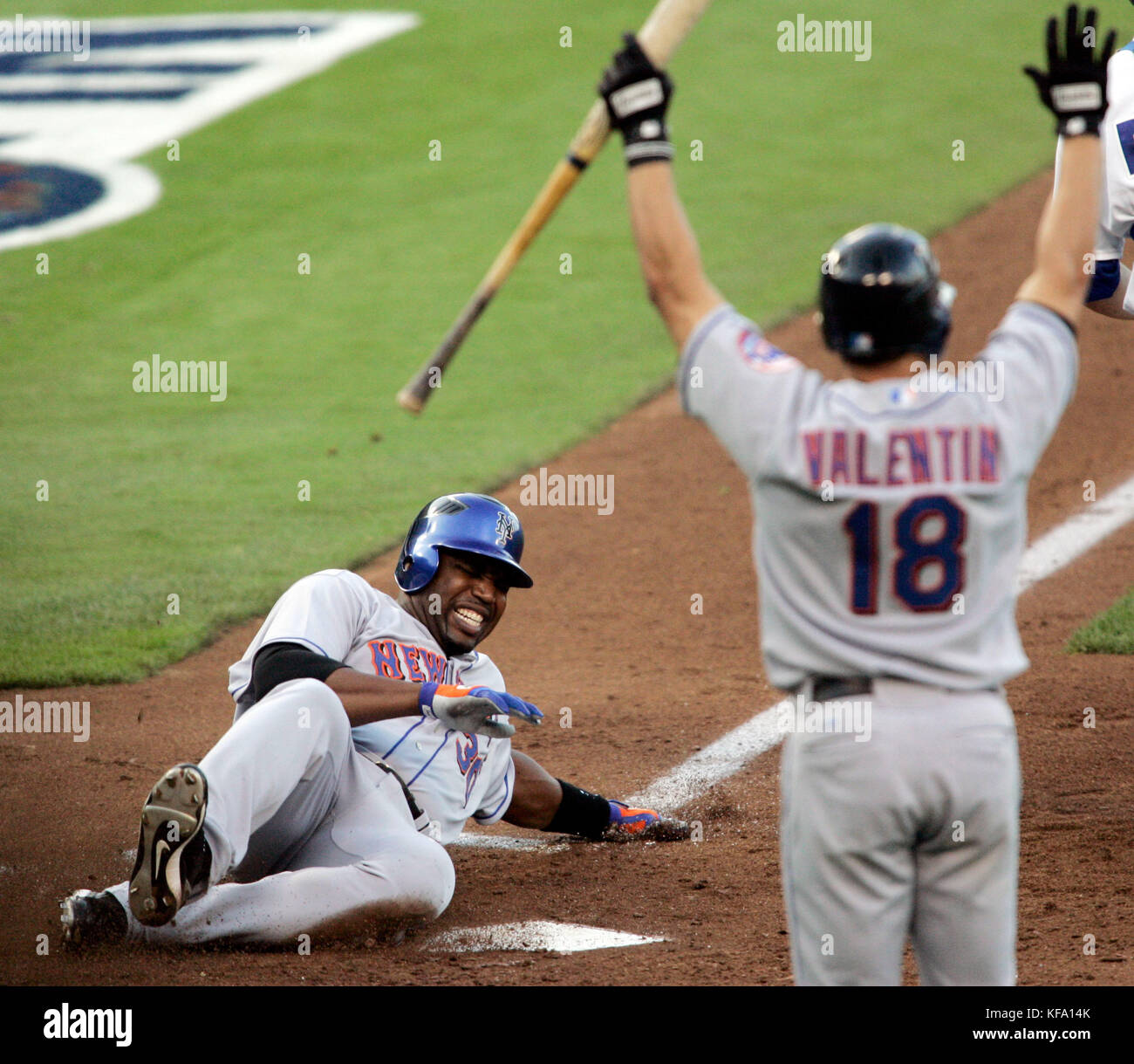 New York Mets' Cliff Floyd, left, slides into home plate as teammate ...