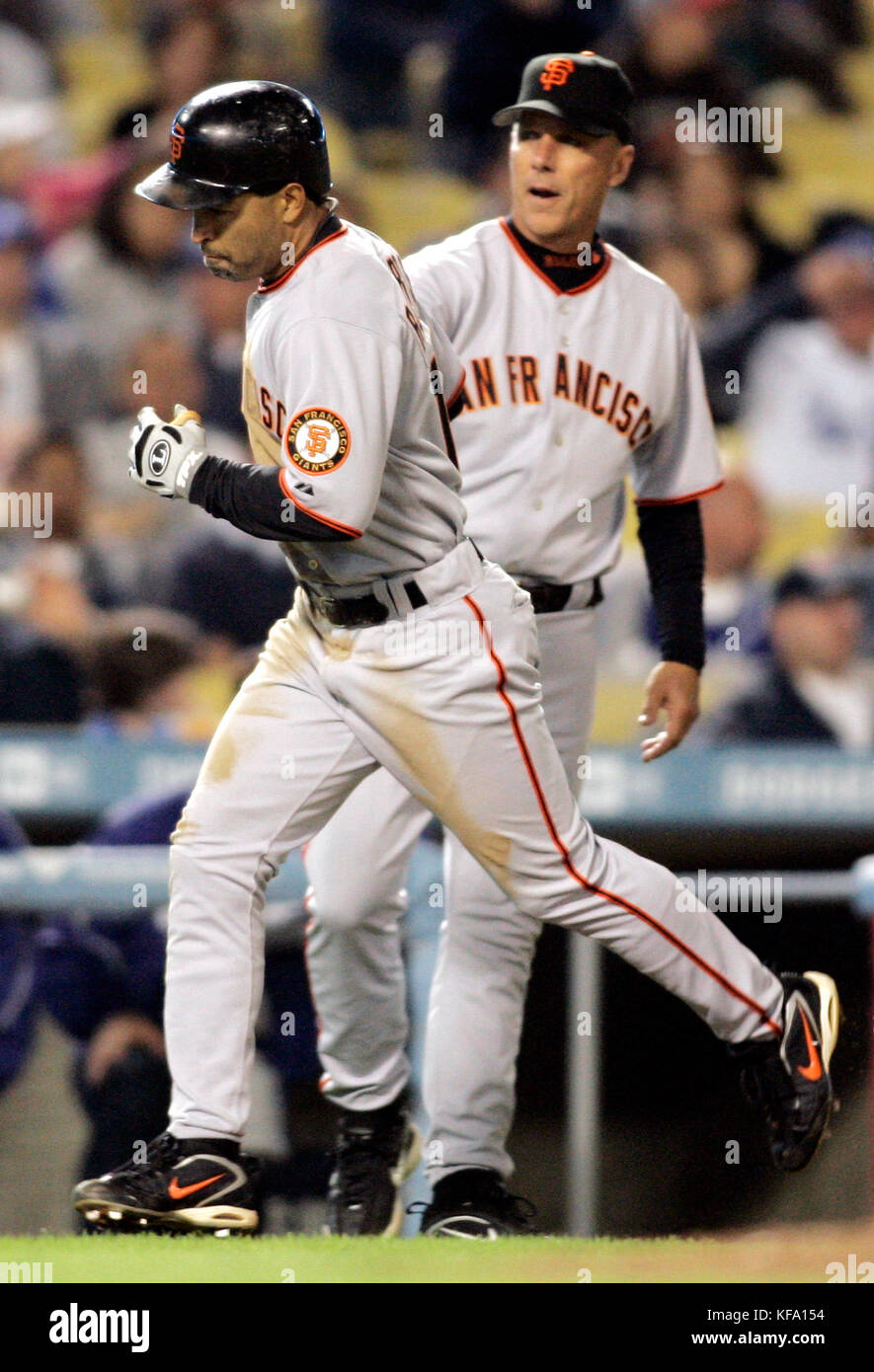 San Francisco Giants' Dave Roberts, left, is greeted by third base ...