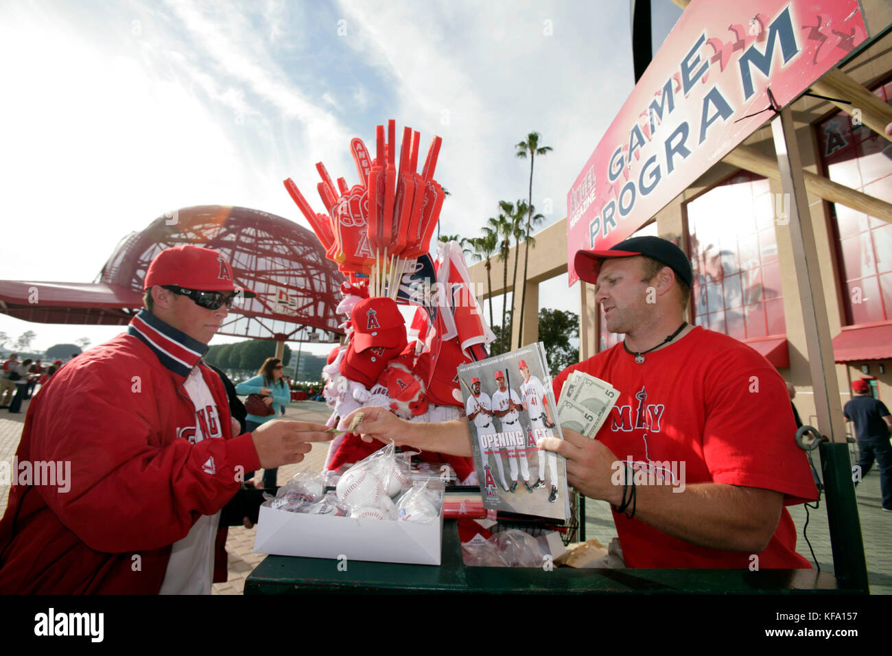 Matt Collette, right, sells an opening day program to fan Gabe Carlson ...