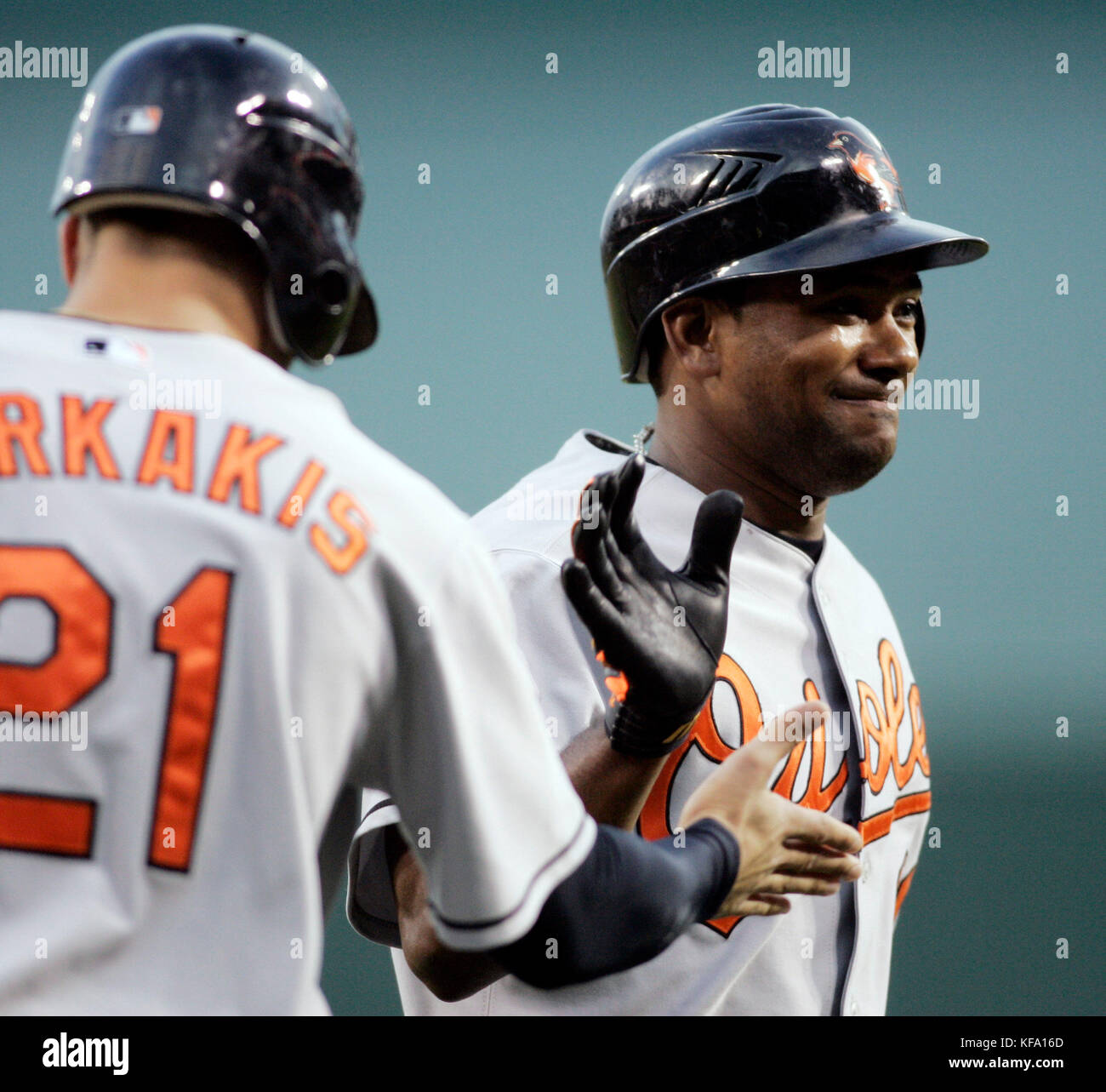 Baltimore Orioles' Miguel Tejada, right, is greeted at home plate by ...