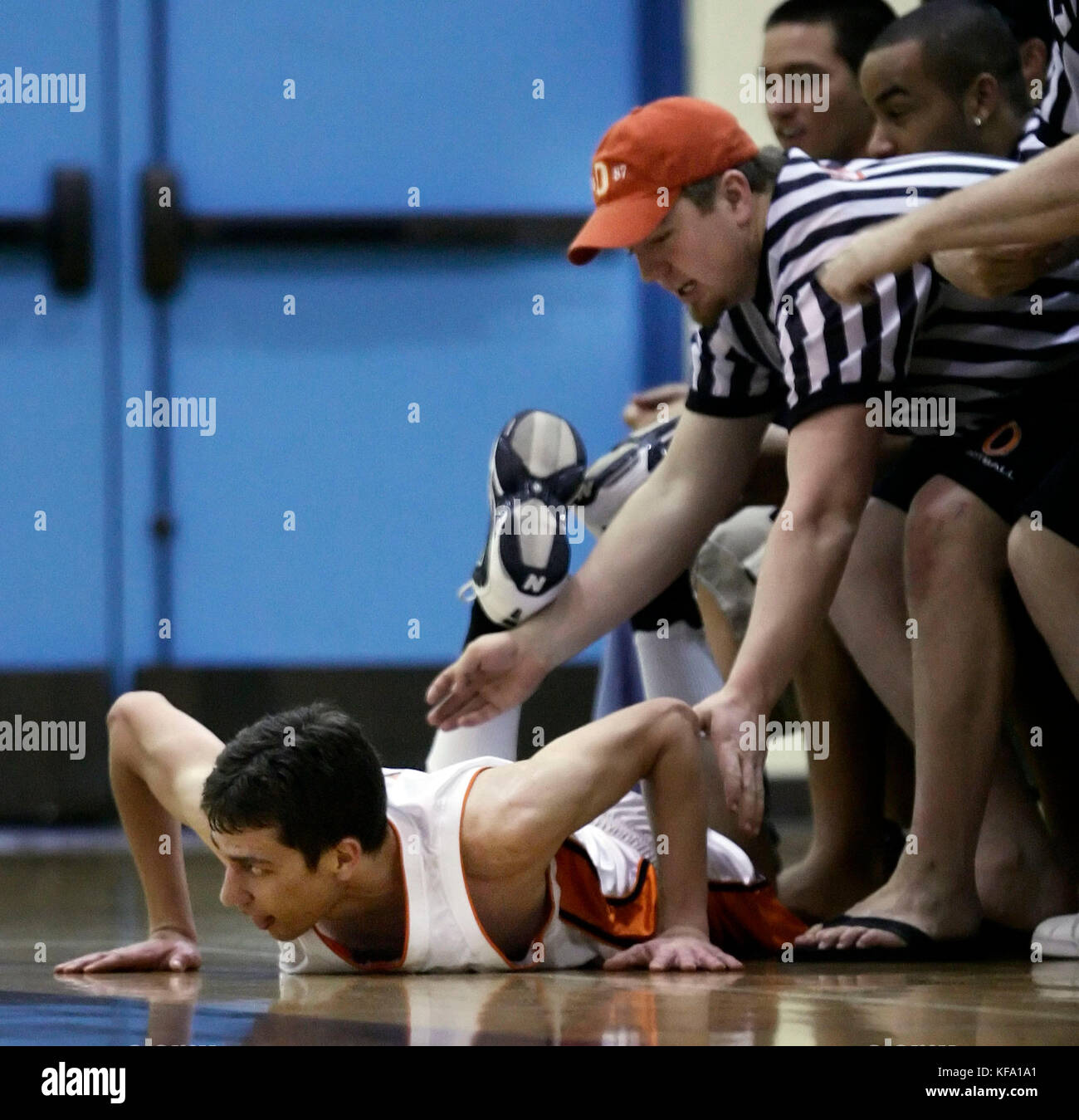 Caltech's Jordan Carlson, left, falls into a crowd of spectators after ...