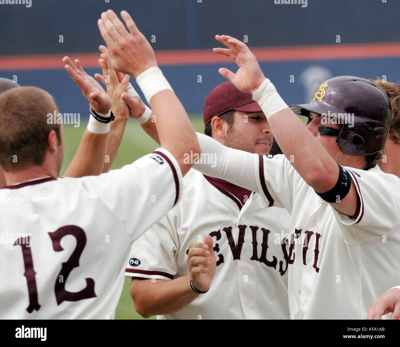 Arizona State's Travis Buck, right, gets high fives from teammates ...