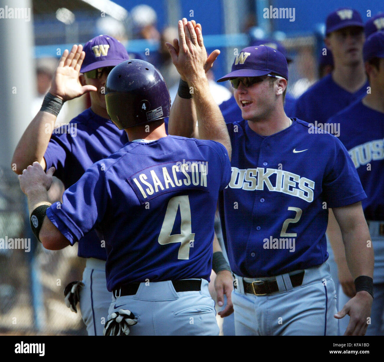 University of Washington runner Greg Isaacson, #4, is greeted by ...