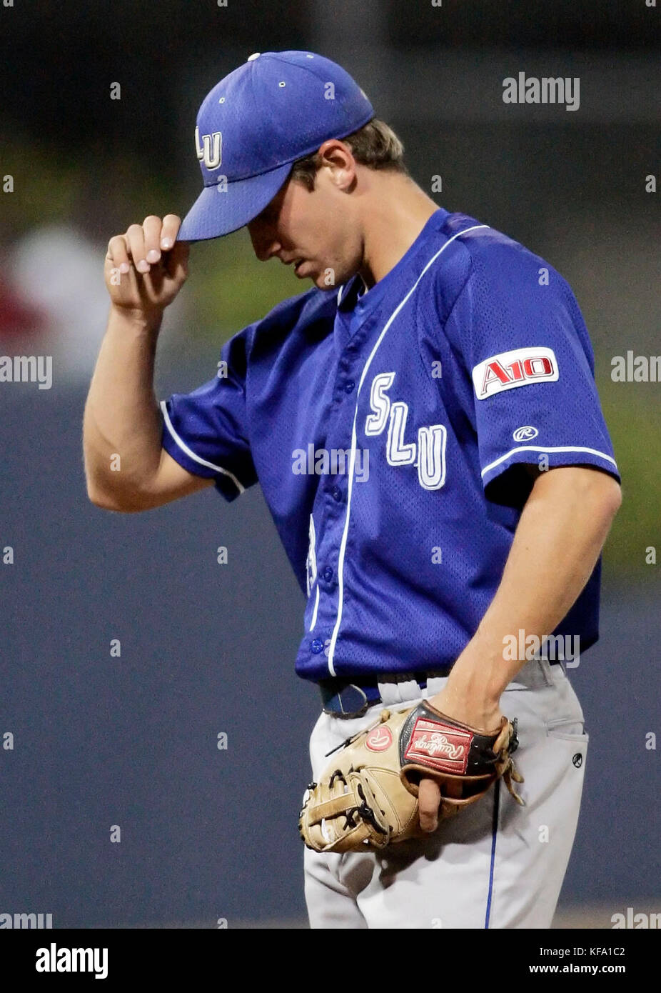St. Louis pitcher Ryan Bird holds the bill of his cap after giving up a ...