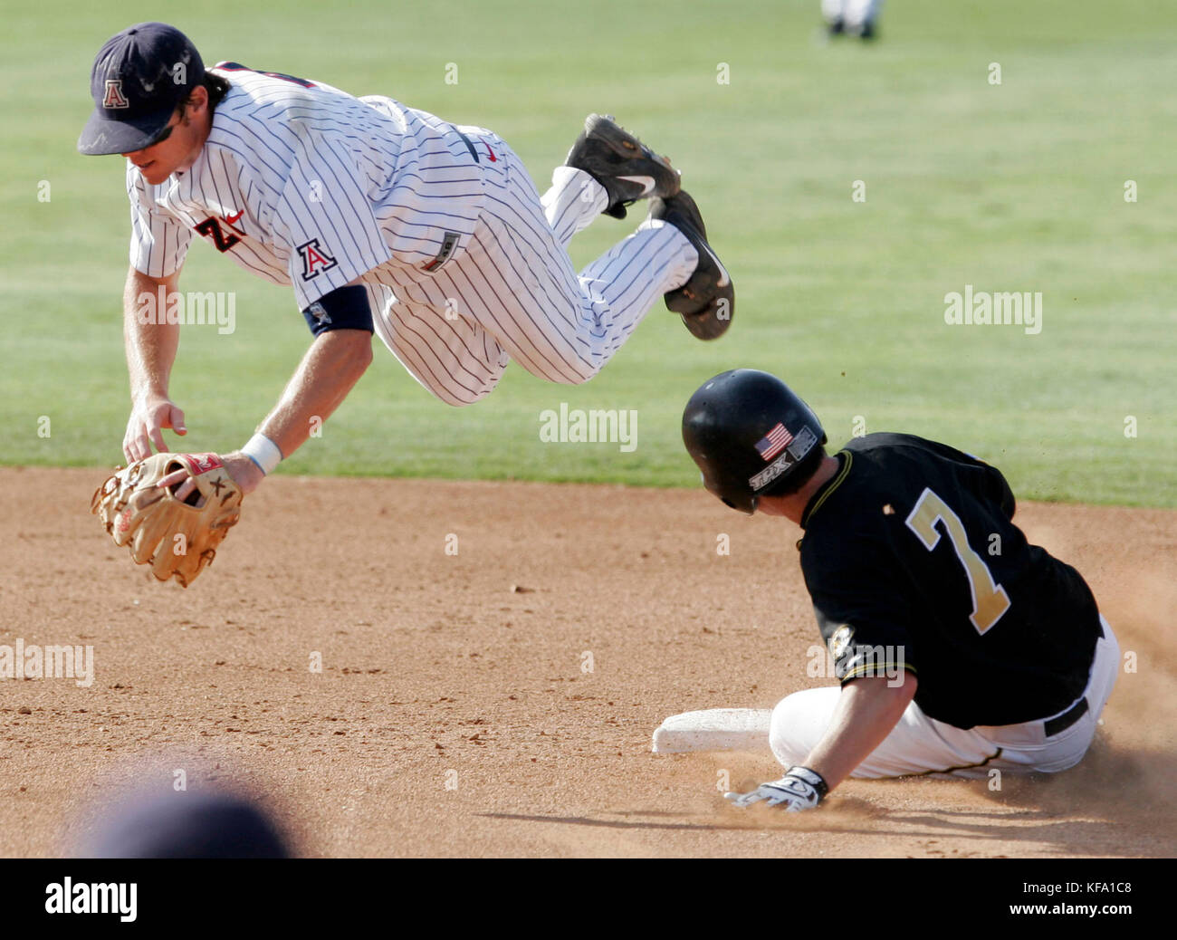 Arizona's shortstop Jason Donald, left, jumps over Missouri's Tyler ...
