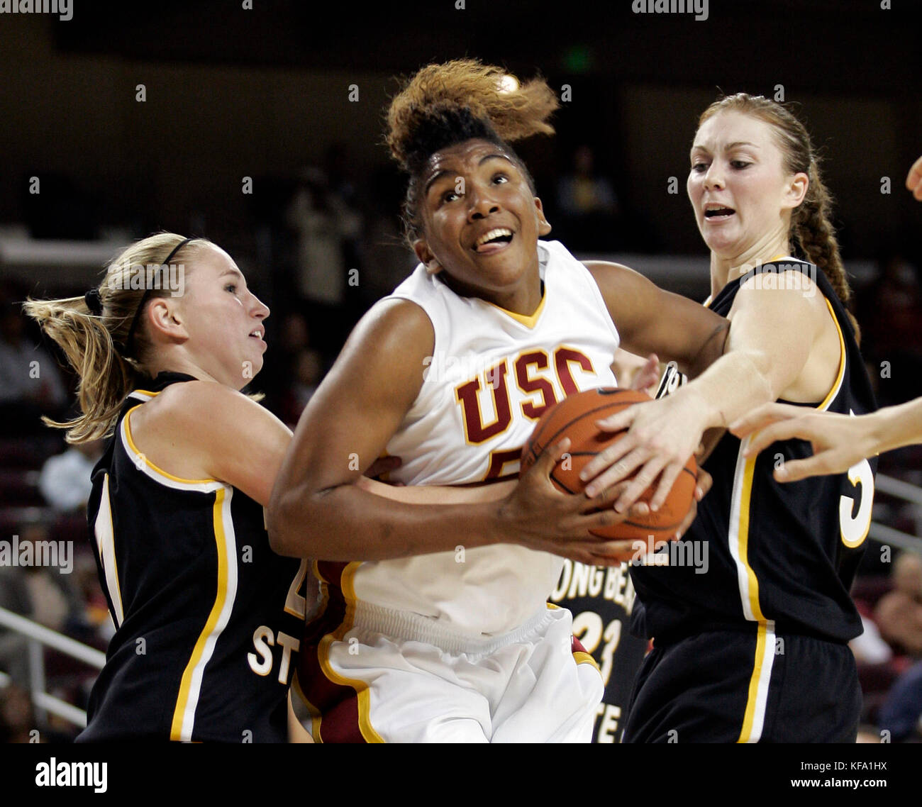 Southern California's Morghan Medlock, center, tries to drive to the ...