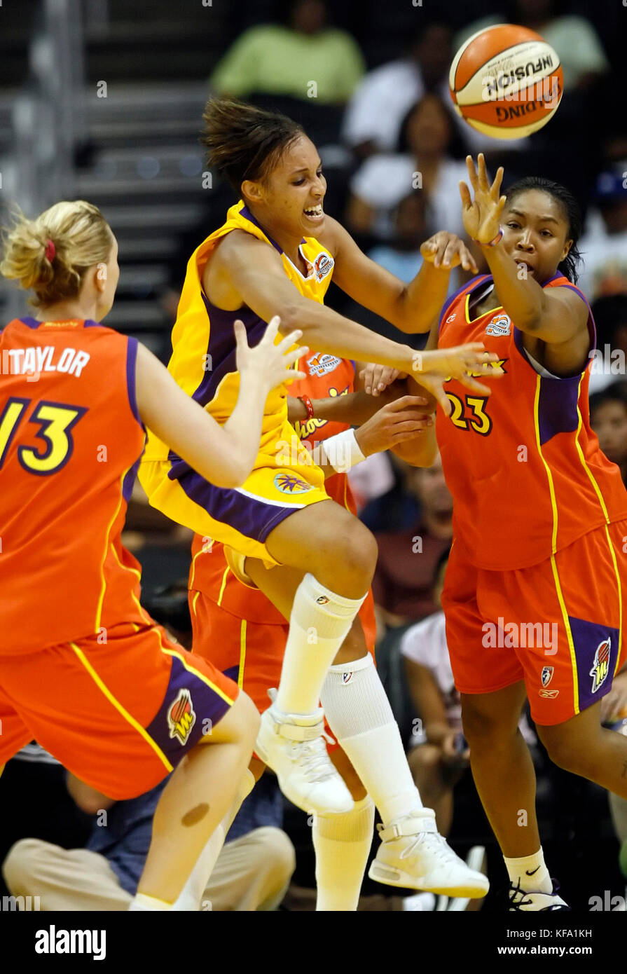Los Angeles Sparks' Tamara Moore, center, passes the ball while being ...