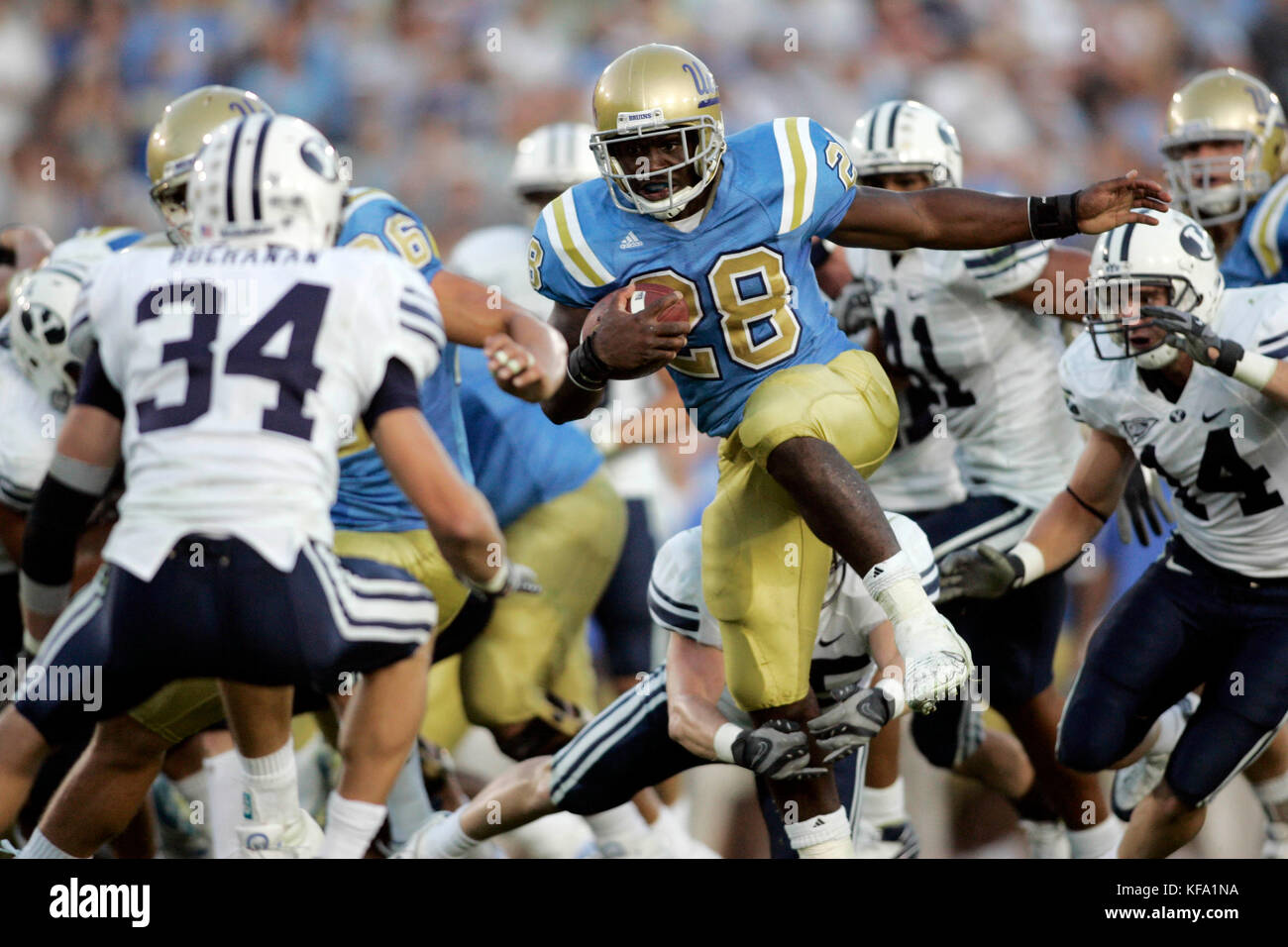 UCLA running back Chris Markey, center, runs for yardage as BYU's Kayle ...