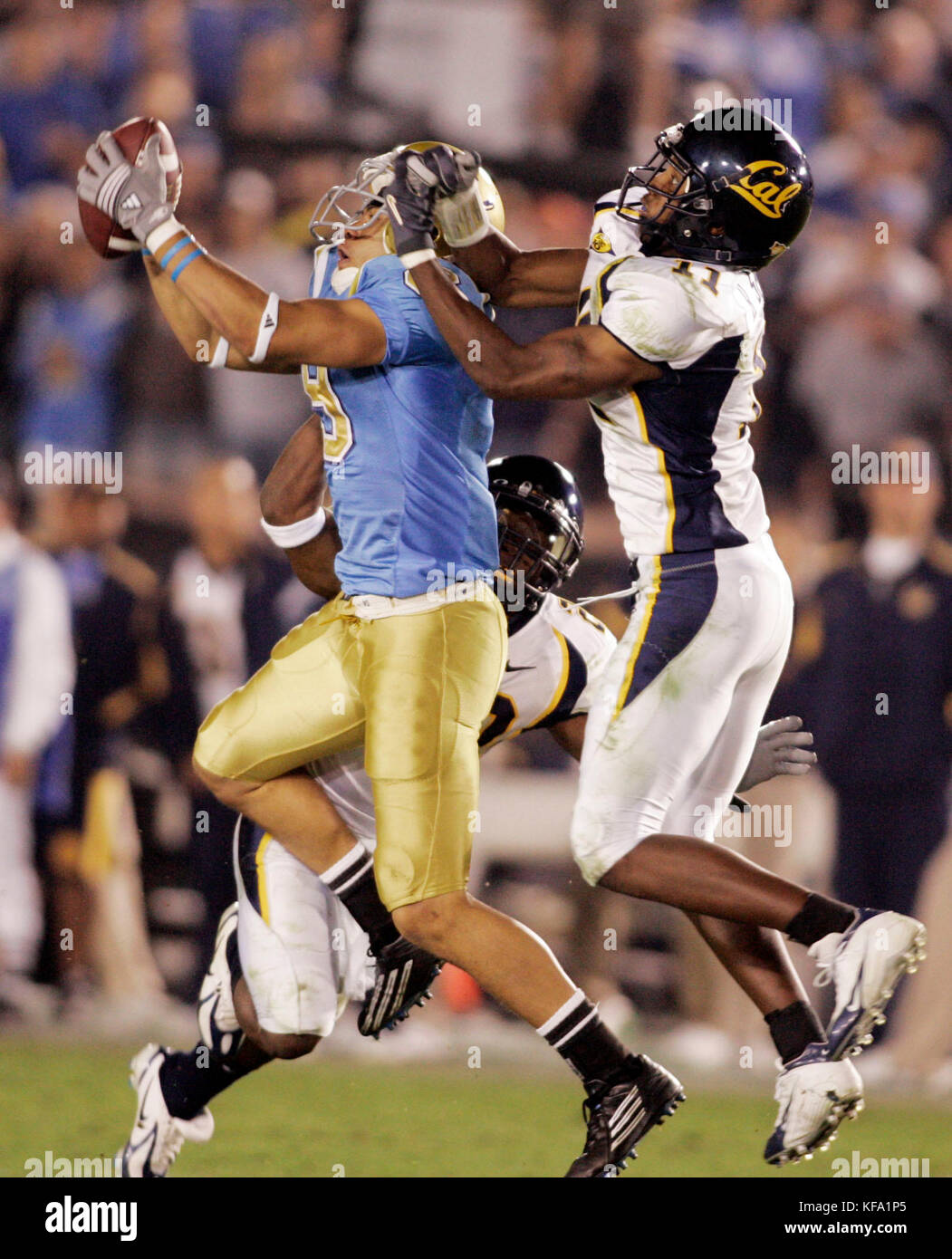 UCLA's Marcus Everett, left, hauls in a pass while defended by ...