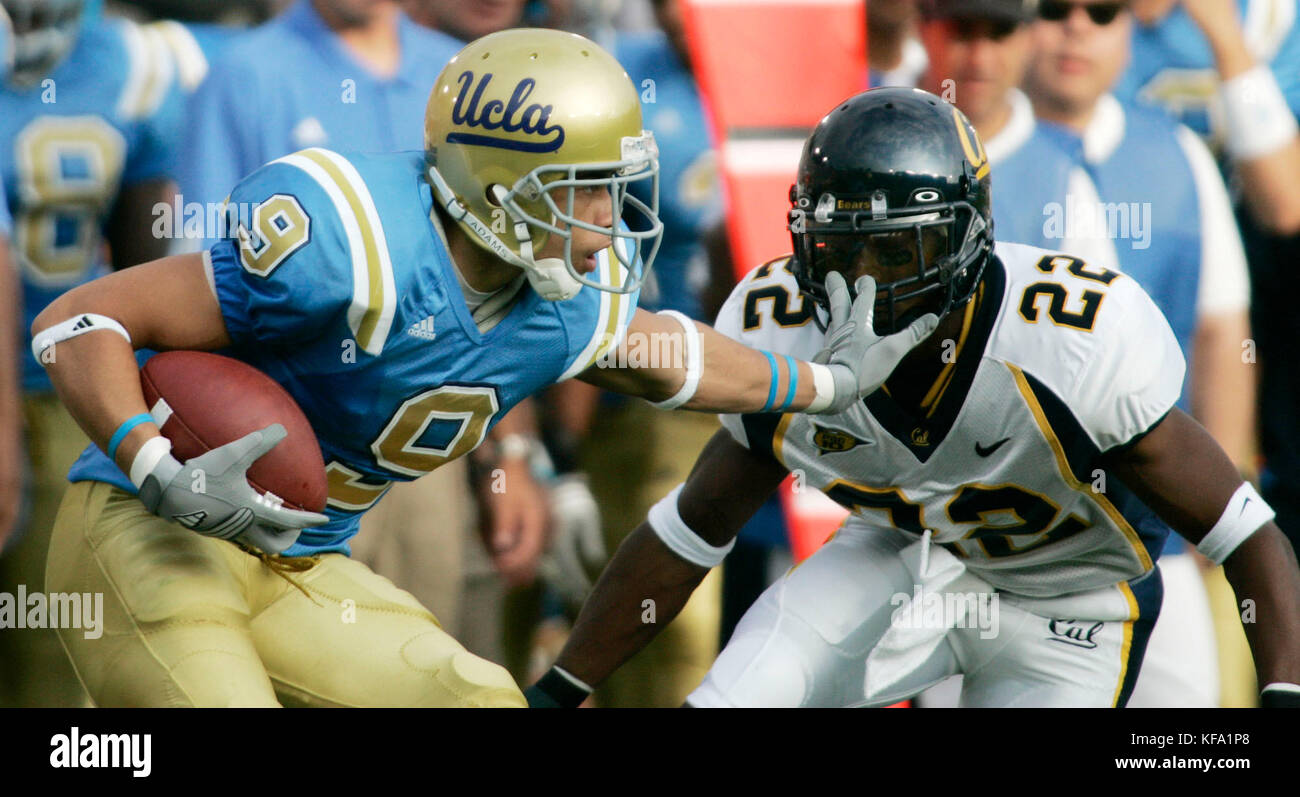 UCLA's Marcus Everett, left, stiff arms California's Tim Mixon after ...