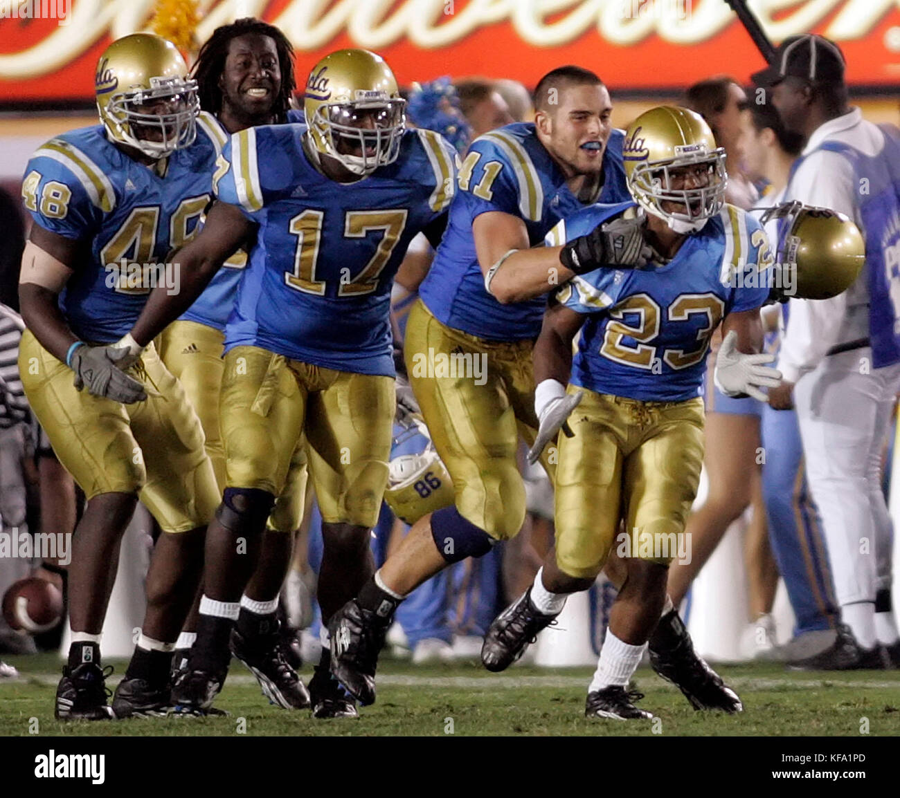 UCLA's Trey Brown, right, is mobbed by teammates after he intercepted a ...