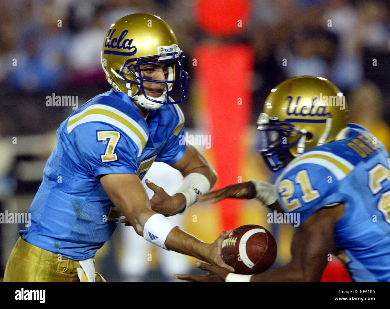 UCLA quarterback Matt Moore (7) hands the ball to running back Maurice ...