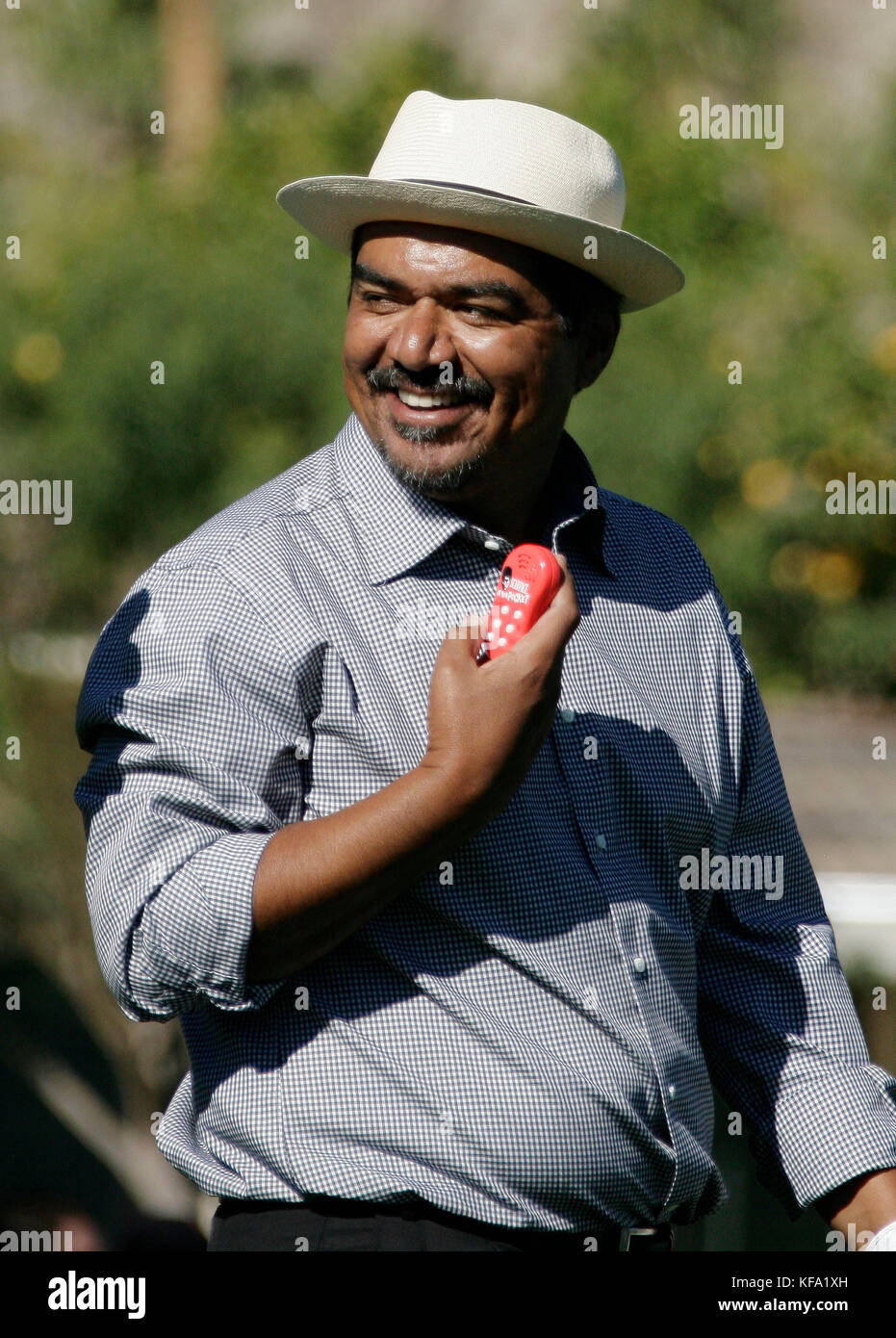 Actor George Lopez shows his "Scarface in a pocket" device during a ...