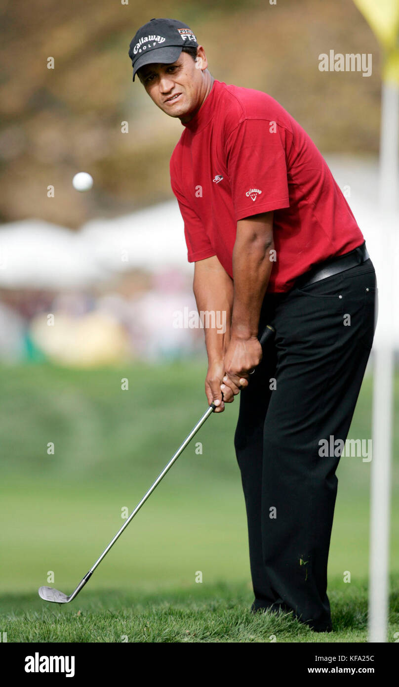 Michael Campbell of New Zealand watches his chip shot at the fifth ...