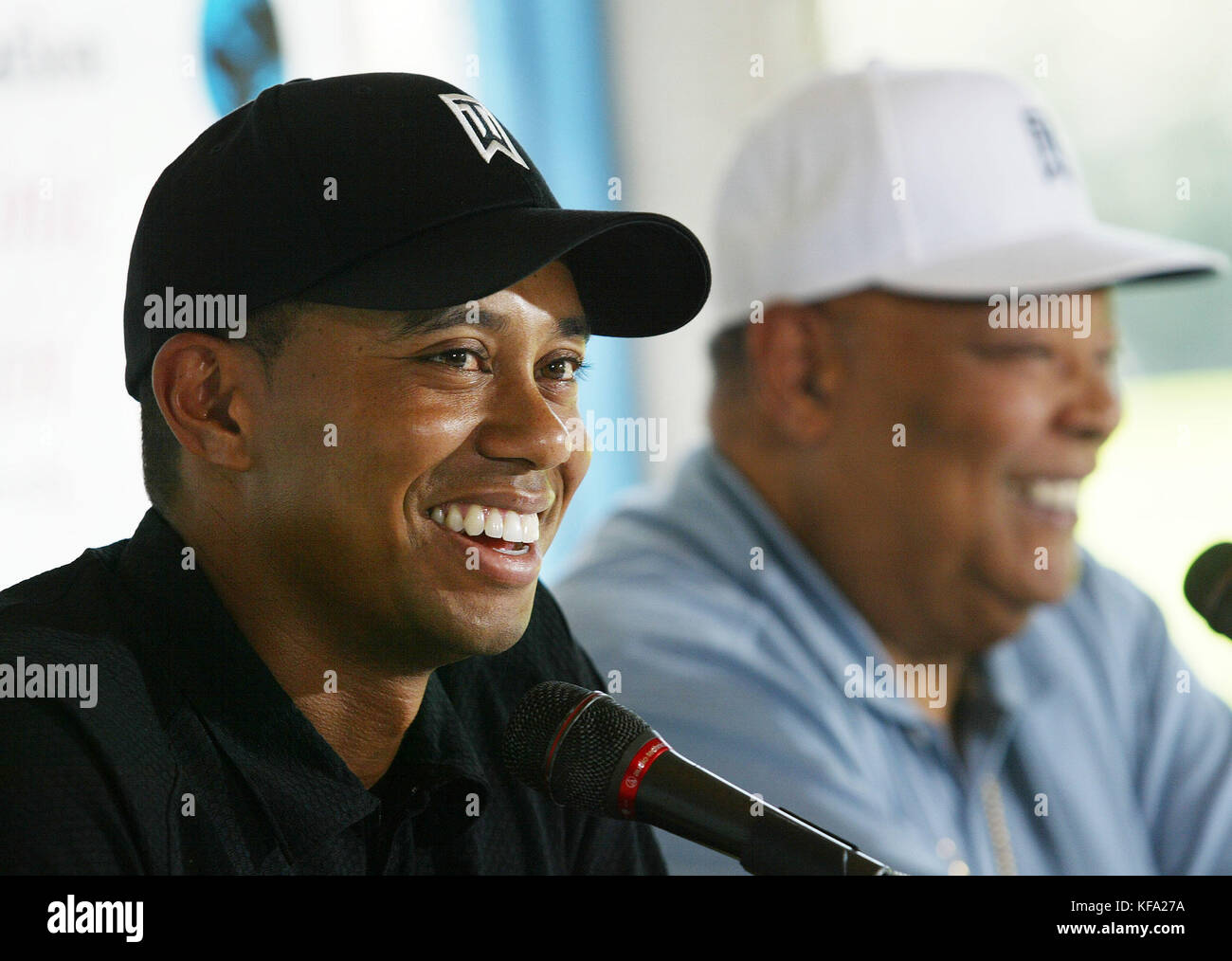 Professional golfer Tigers Woods, left, smiles along with his father ...