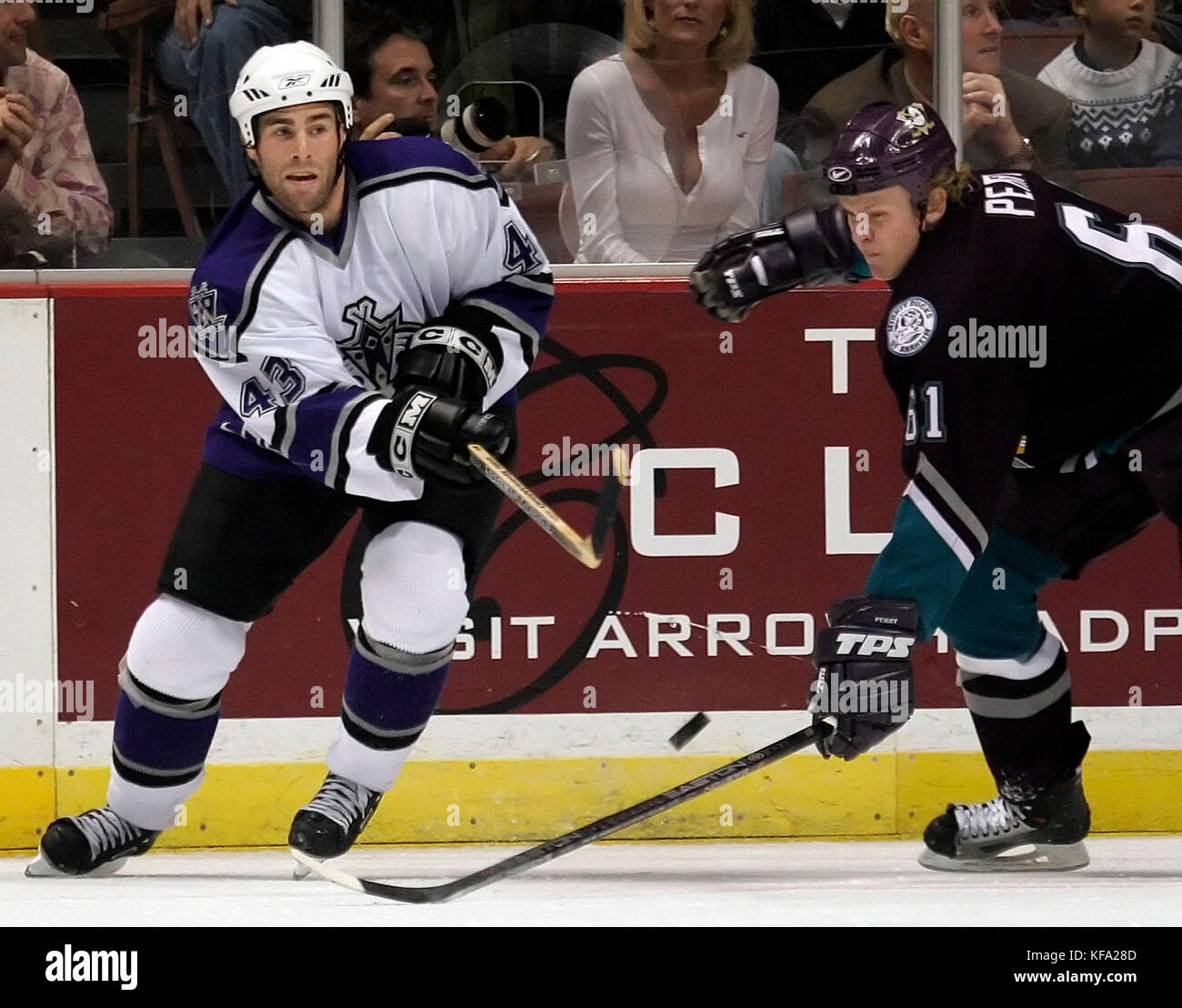 Los Angeles King' Mike Weaver, left, flips the puck over the stick of ...