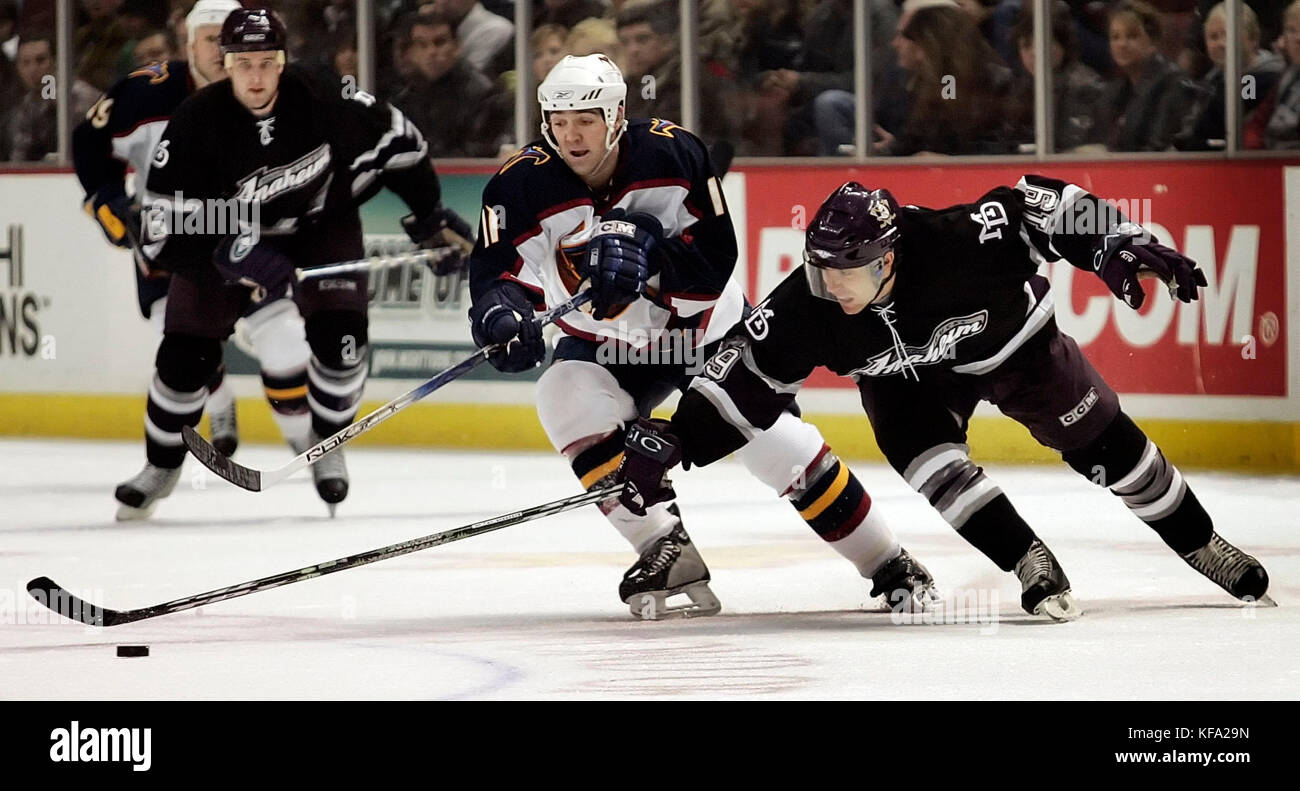 Anaheim Mighty Ducks' Andy McDonald, right, lunges for the puck with ...