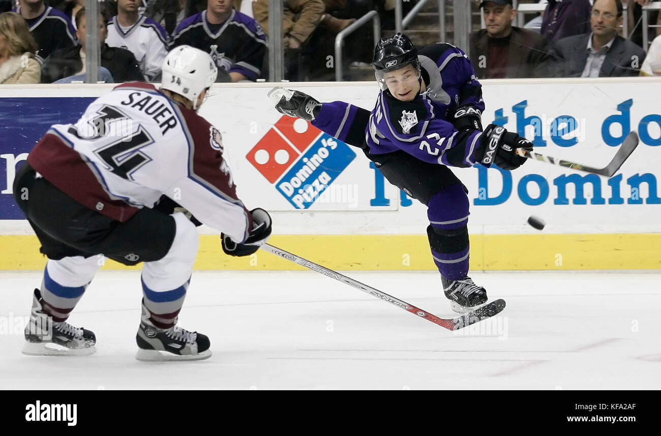 Los Angeles Kings' Dustin Brown, right, takes a slap shot on goal as ...