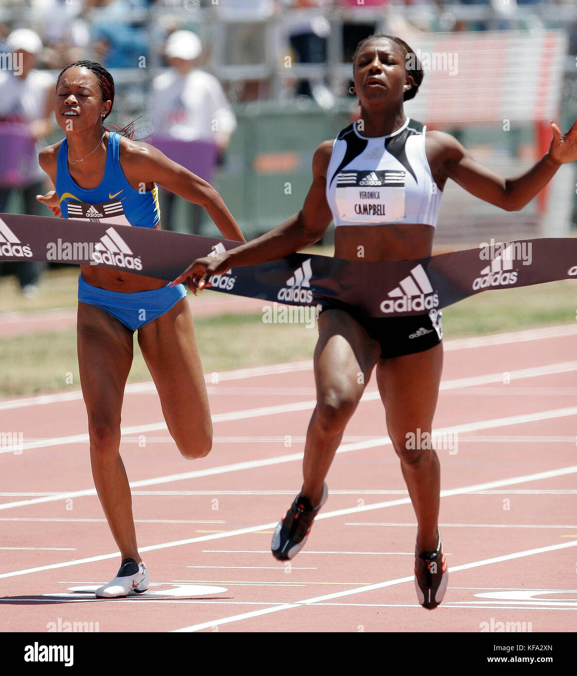 Veronica Campbell, right, crosses the finish line first, beating second ...