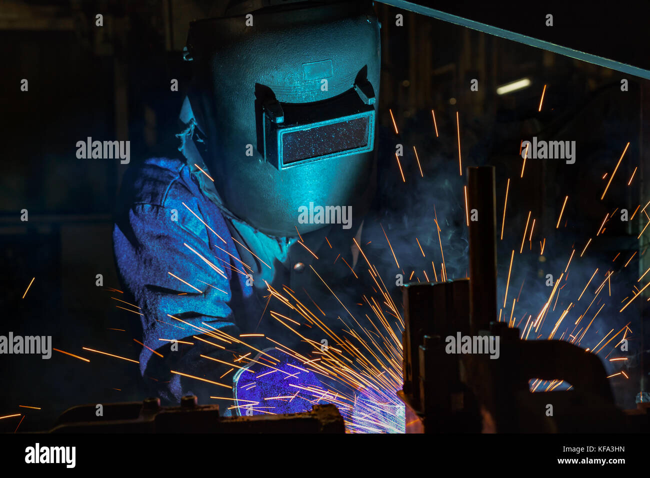 Industrial worker is welding in automotive part factory Stock Photo - Alamy