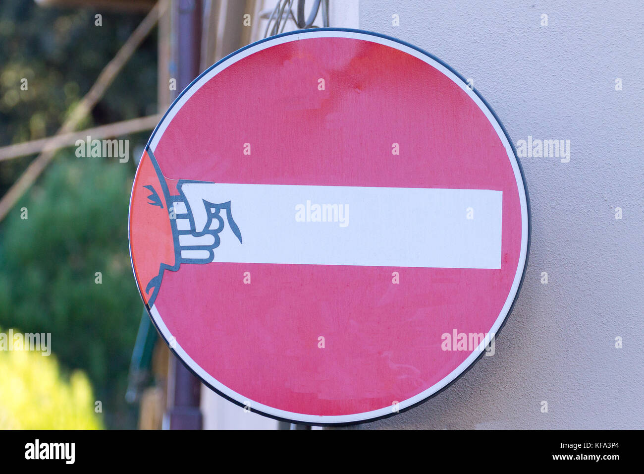 Road sign with an hand that break out the signal, street art ...