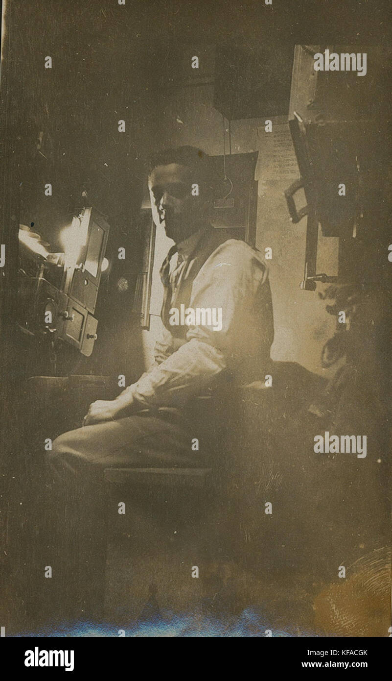 Stan Allan seated in projection room at Haymarket Theatre, Sydney, 1920 ...