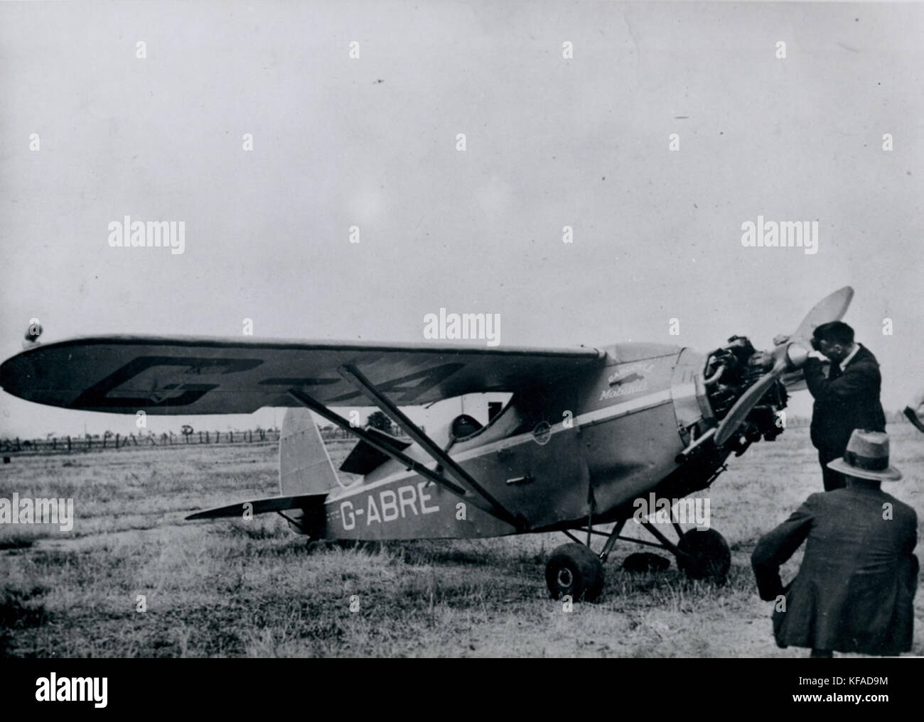 This historical image shows Arthur Butler servicing his Comper Swift ...