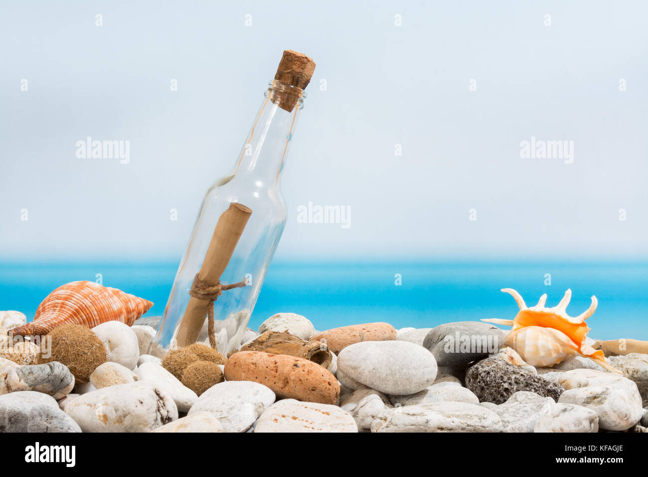 Message in bottle on the beach with stones Stock Photo - Alamy