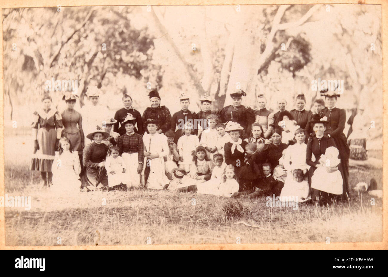 This outdoor photograph from 1884 captures a group portrait of women ...