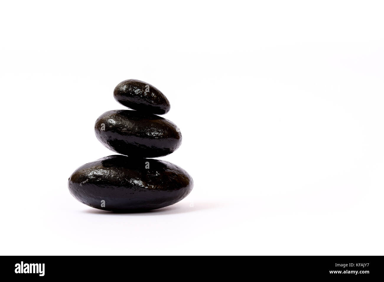 Black wet stones on white background Stock Photo - Alamy