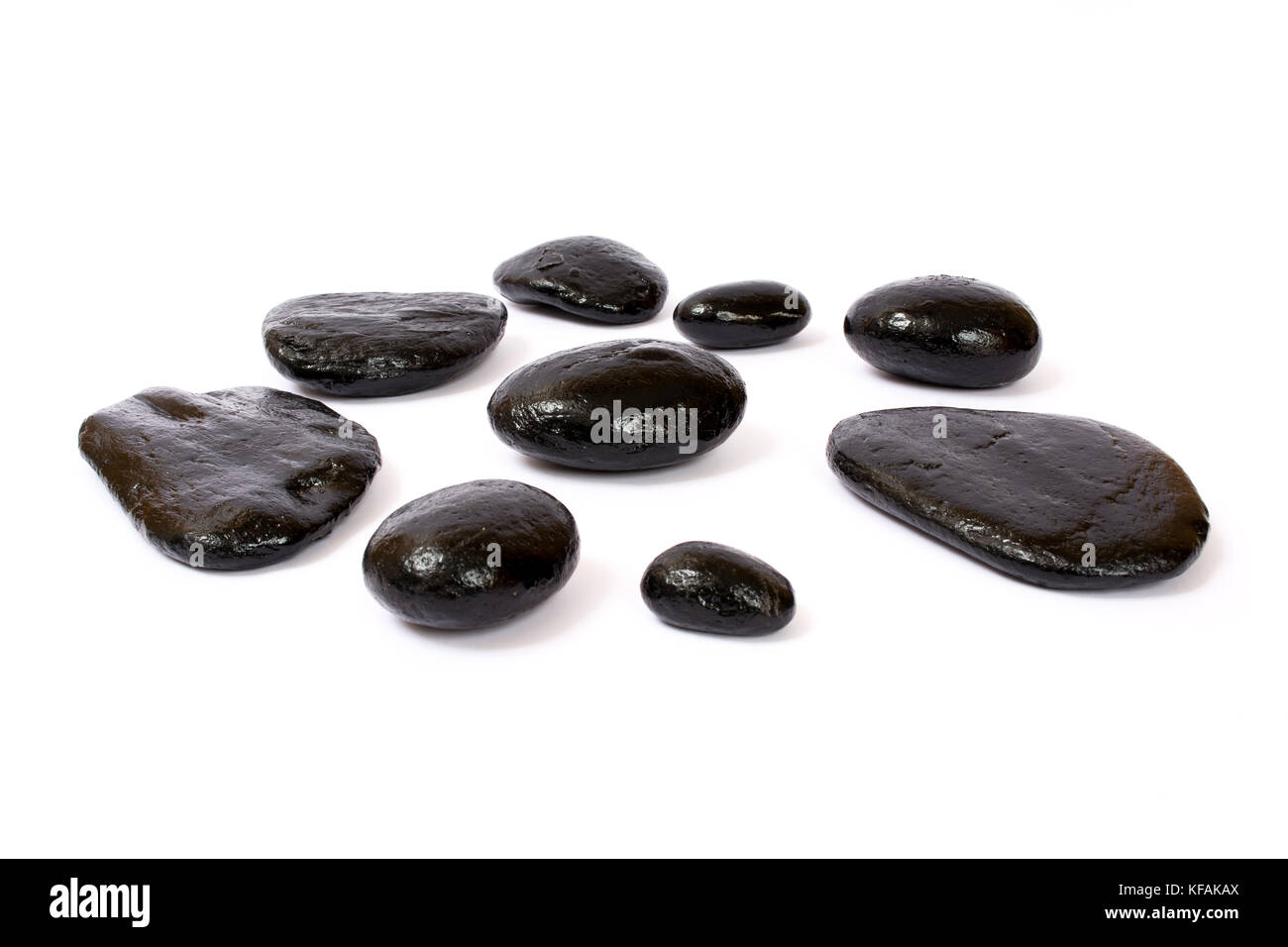 Black wet stones on white background Stock Photo - Alamy