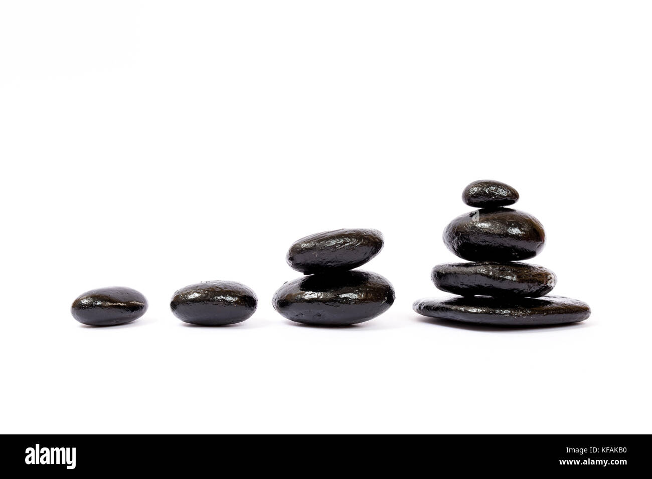 Black wet stones on white background Stock Photo - Alamy