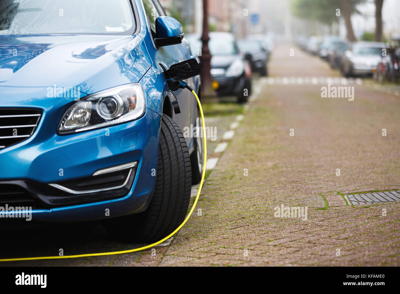 The car being charged on a street of a city Stock Photo - Alamy